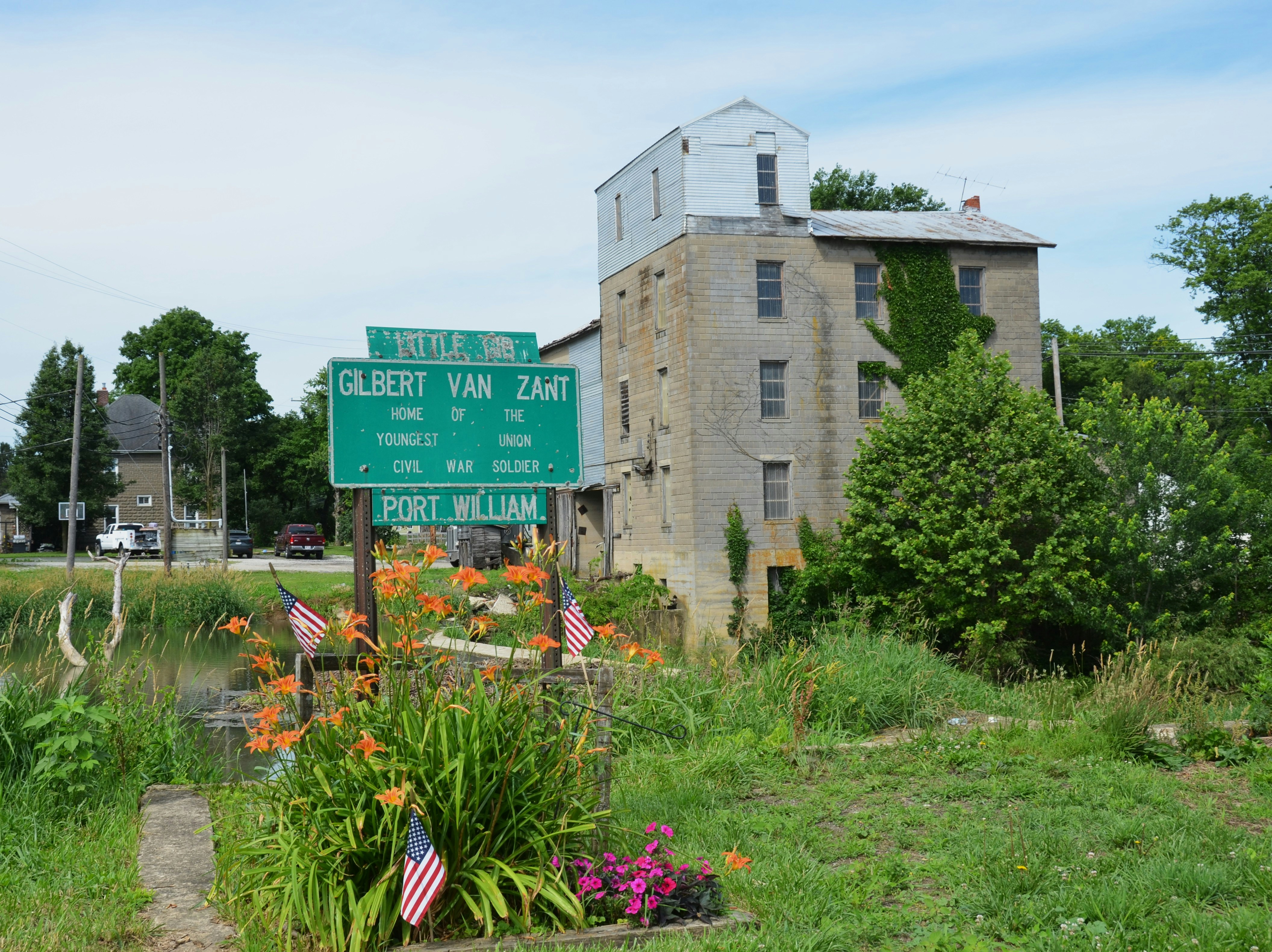 Green Sign and Weathered Mill: A Quiet Corner of Small-Town History