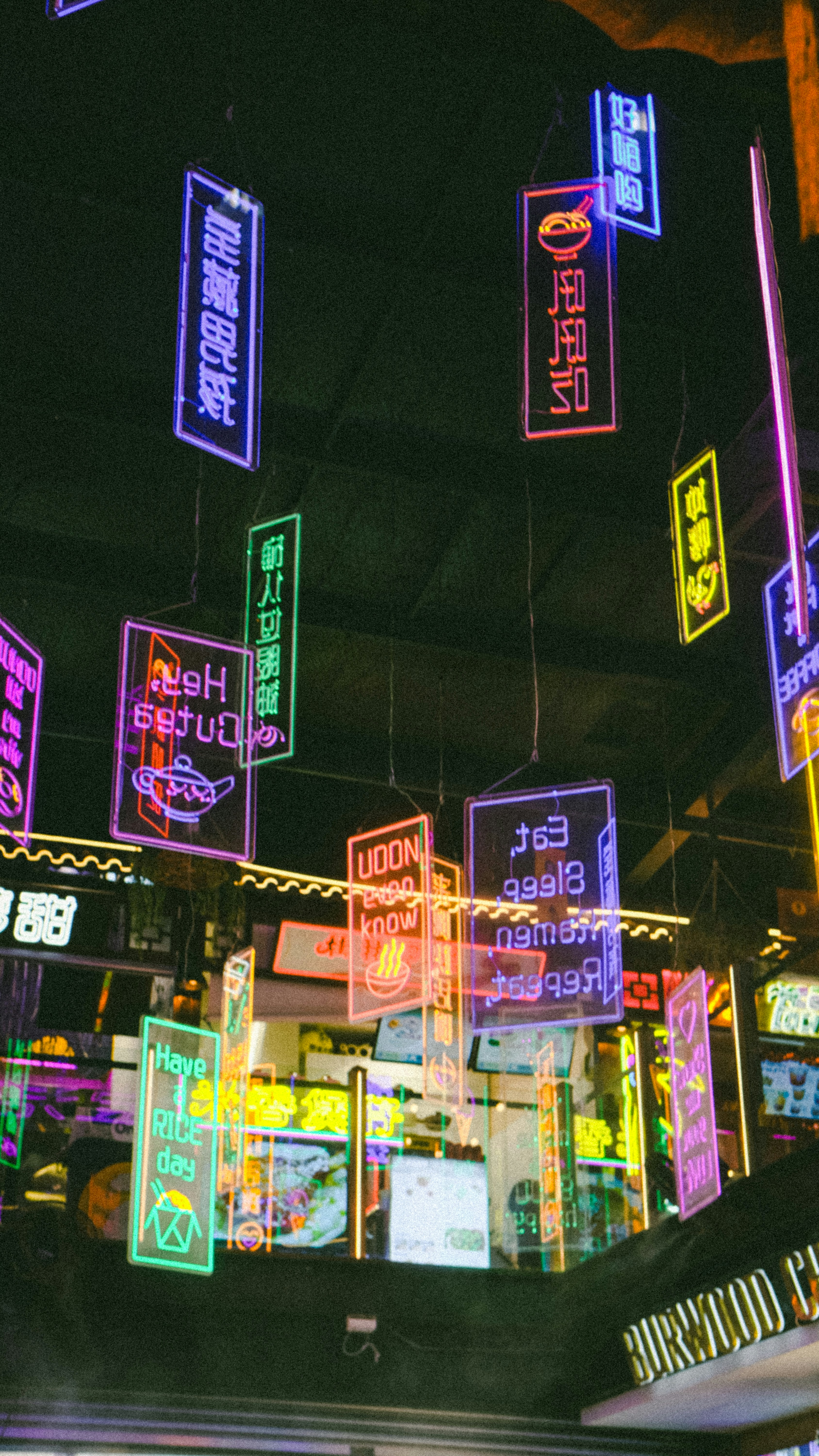 Neon Corridor: Floating Signs Draped Over a Midnight Market