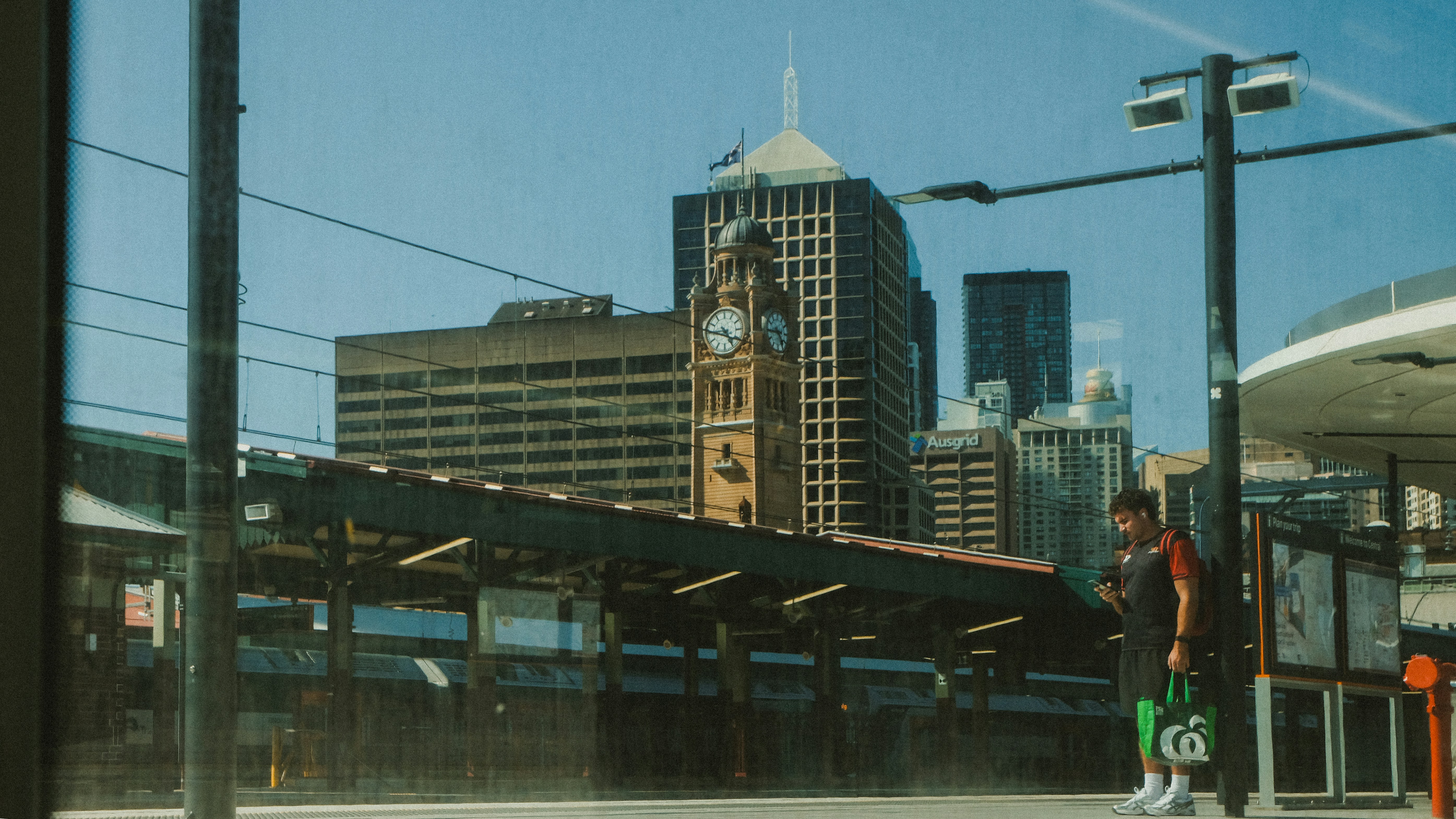 Clock Tower in the Pulsing Downtown: People, Trains, and Towers