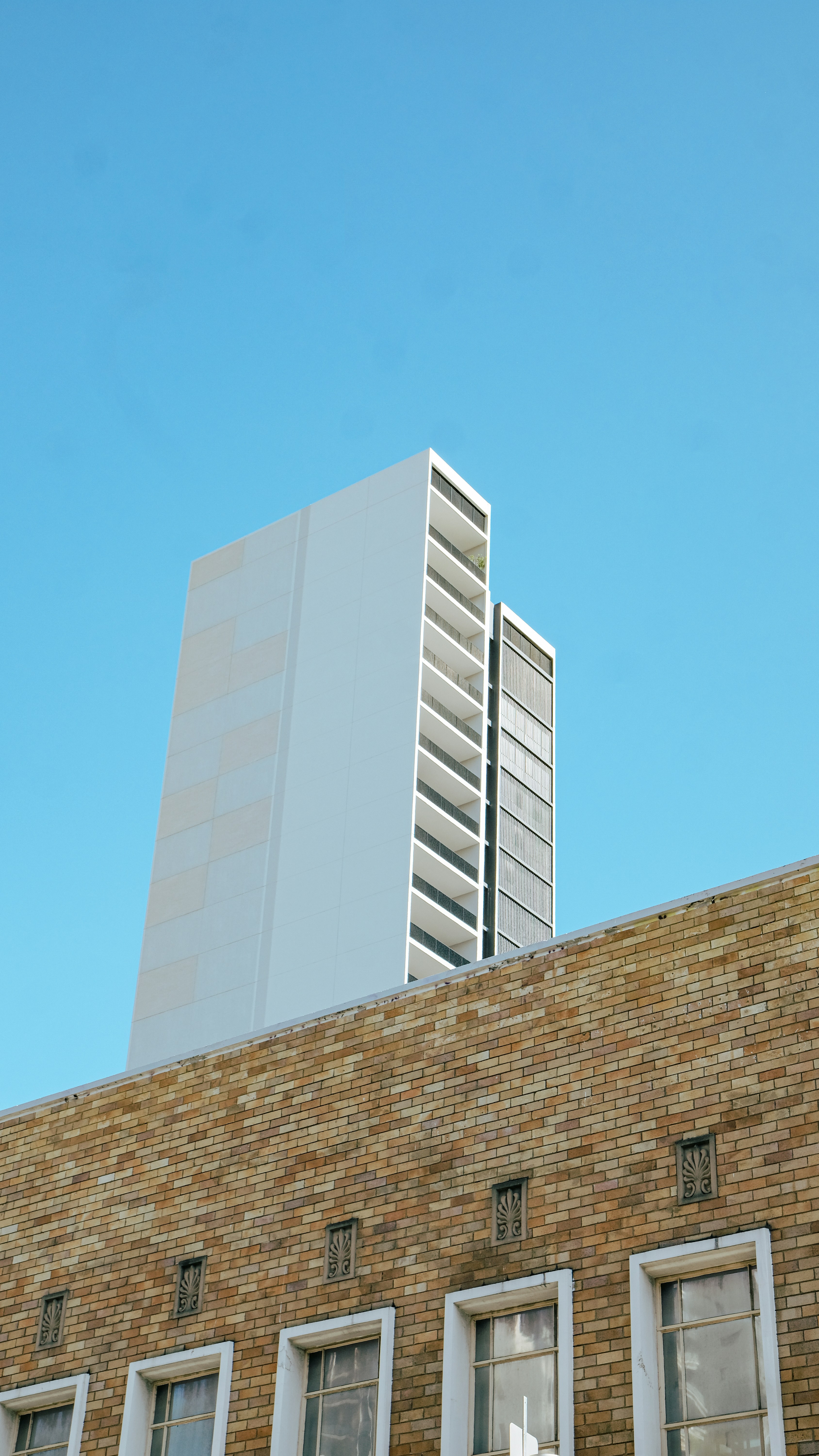 Skyward Horizons: A Modern Tower Pierces the Calm Blue