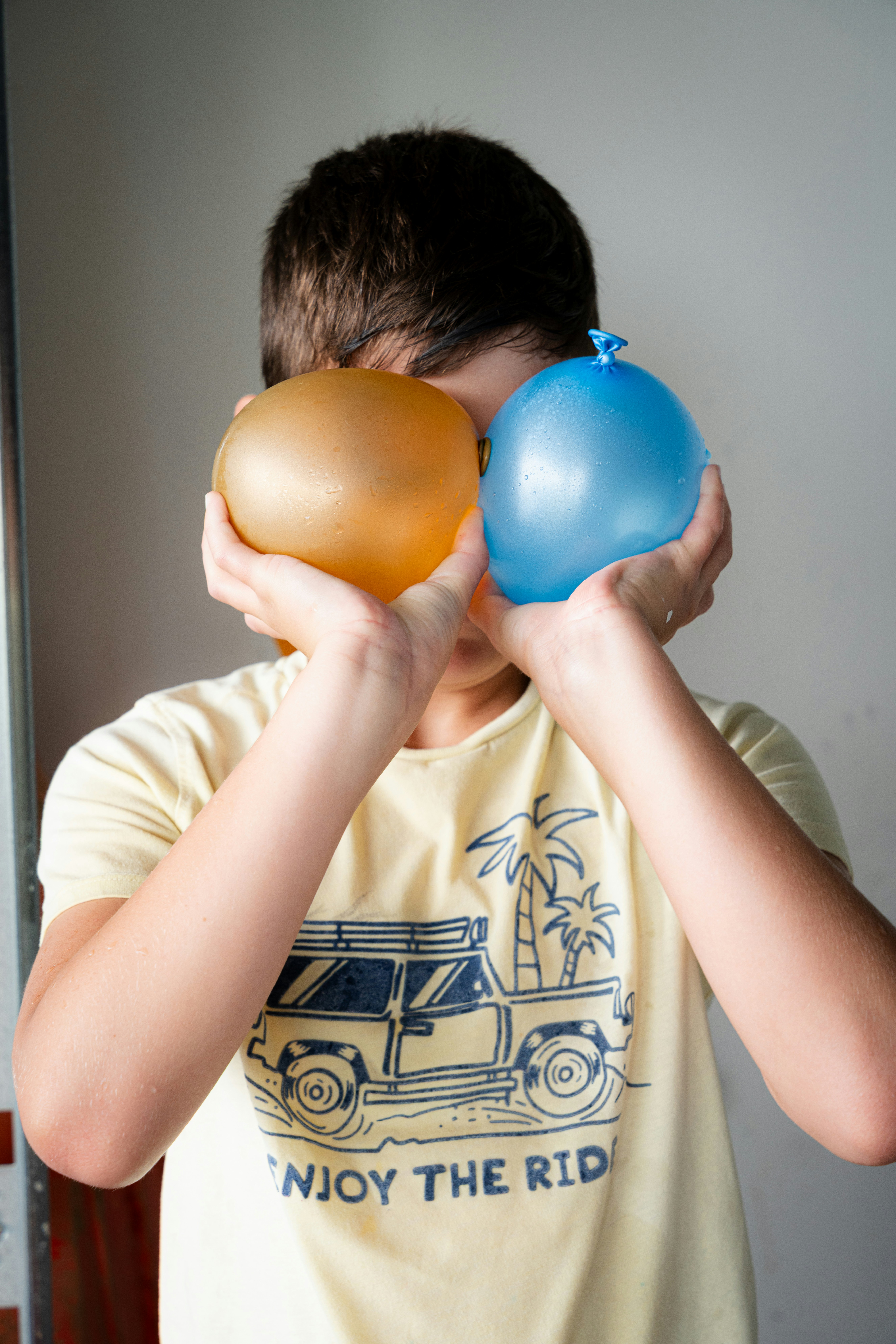 Hidden Face: Balloons Frame a Youthful Moment