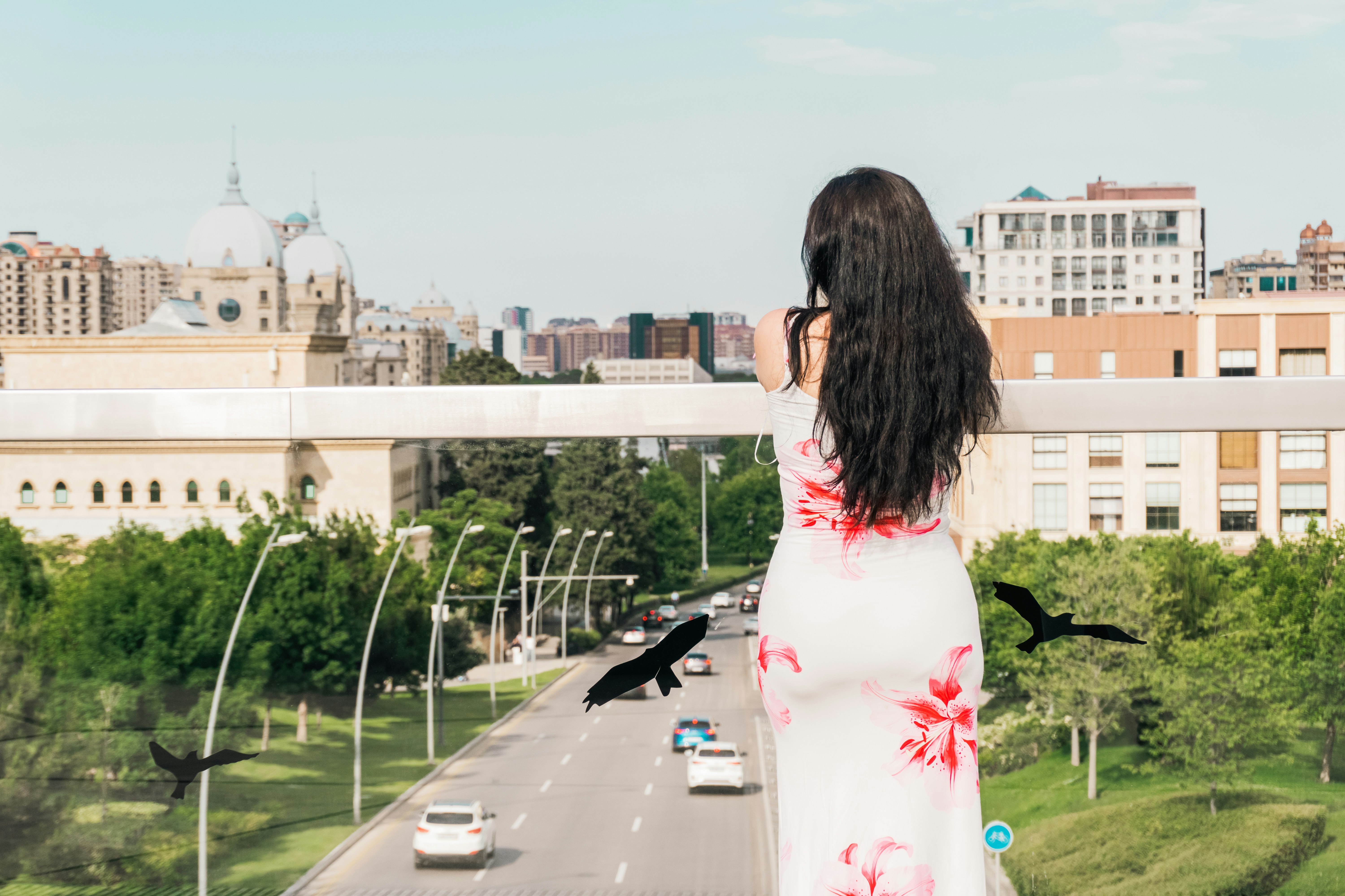 Veranda of Calm: A Woman in White Florals Overlooking the City