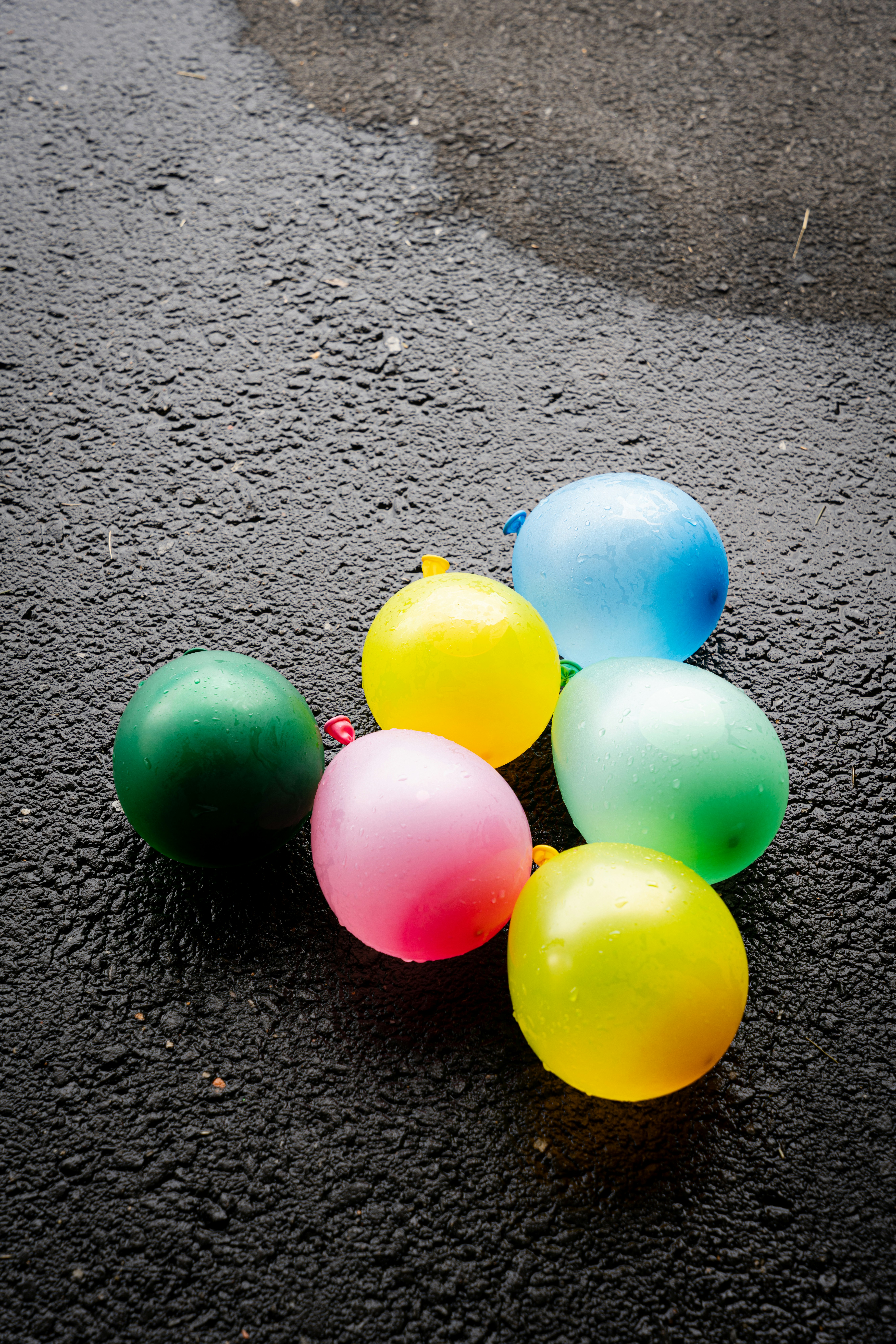 Colorful Orbs on Rain-Soaked Asphalt