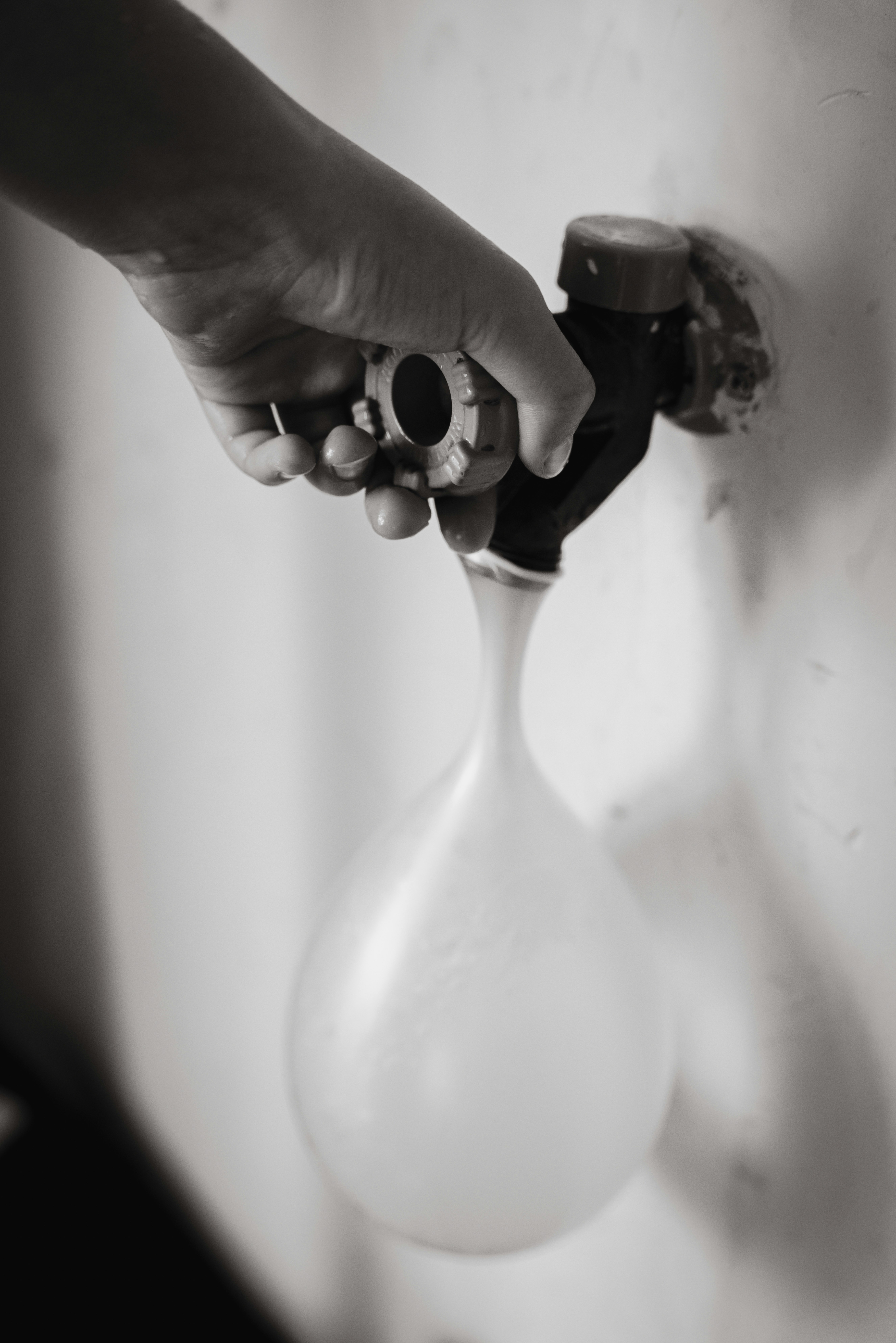 A Quiet Tap: The Hand and Lightbulb Bulb in Ink-dark Glass