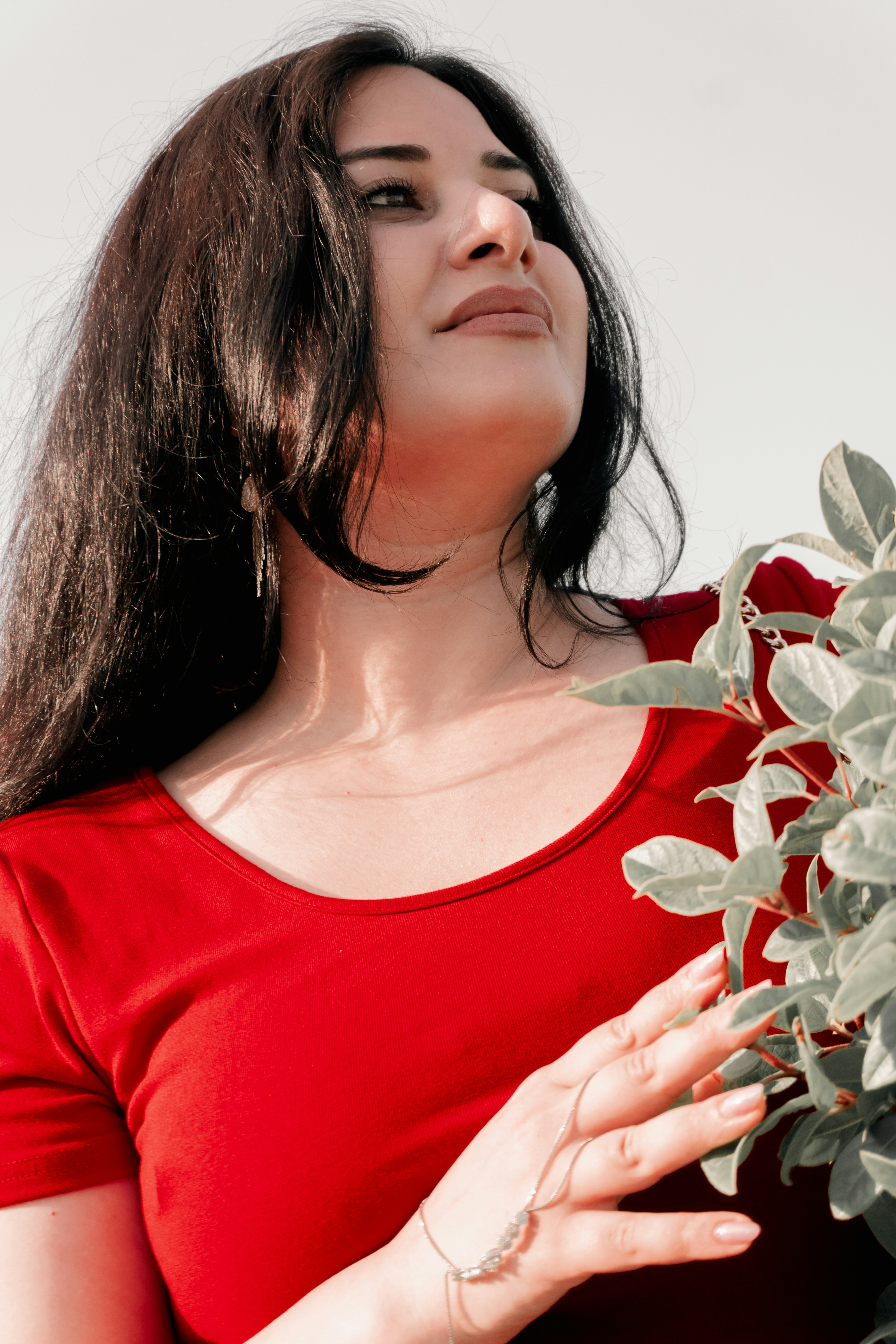 Red Enchantment: Portrait of Quiet Confidence with Sage Leaves