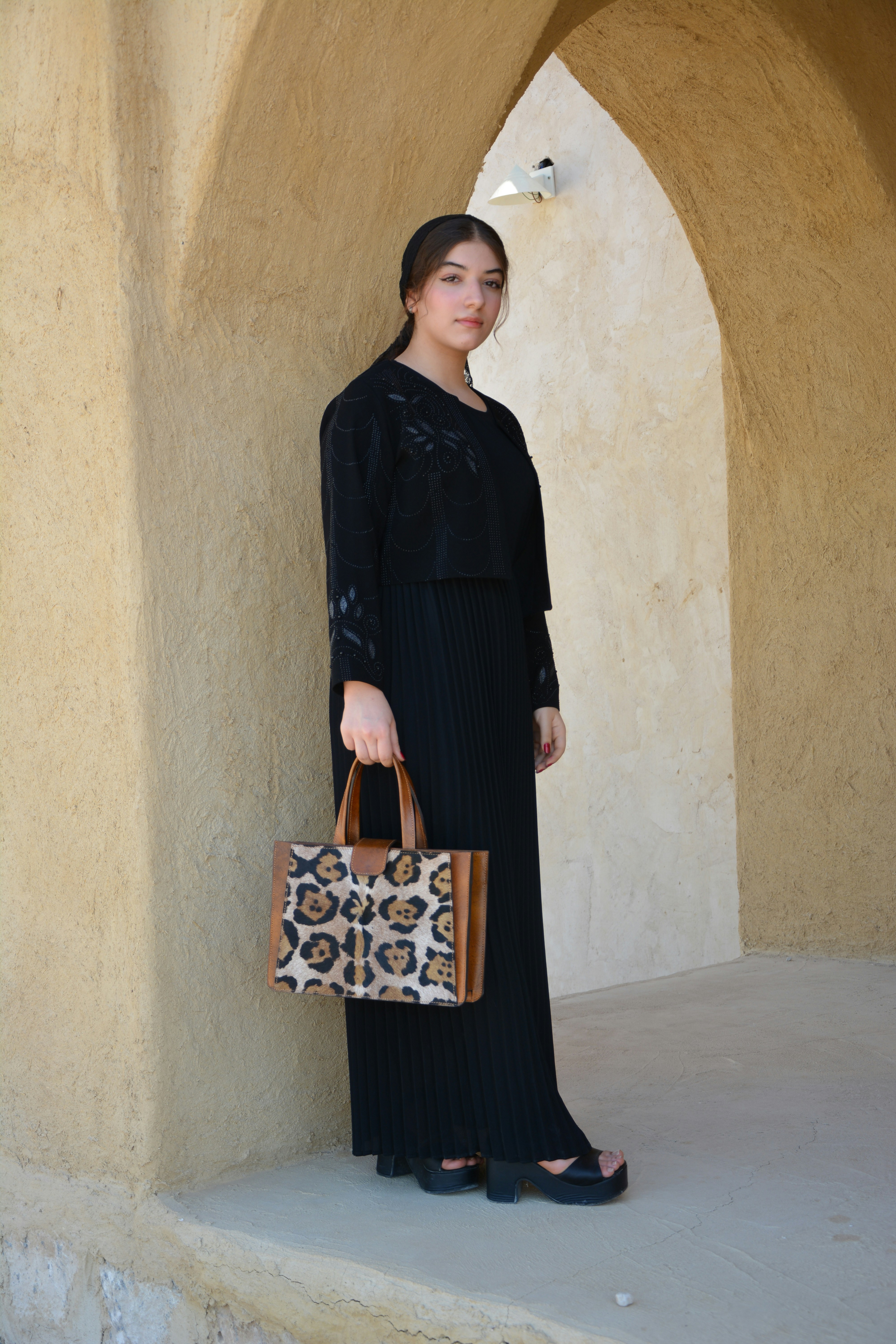 Elegance in Shadow: A Portrait Beneath desert arches