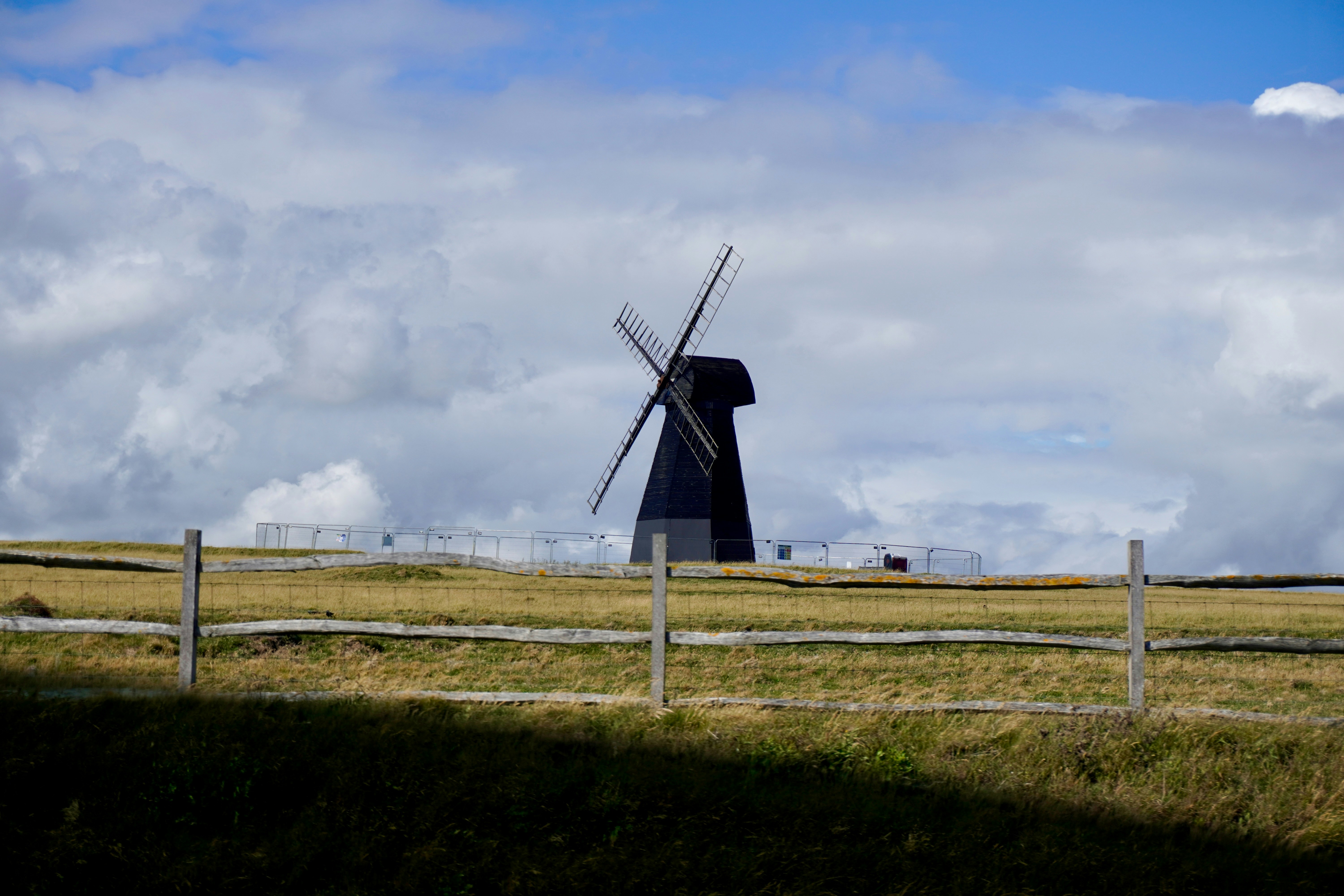  solitary windmill on rolling plains under a bright sky