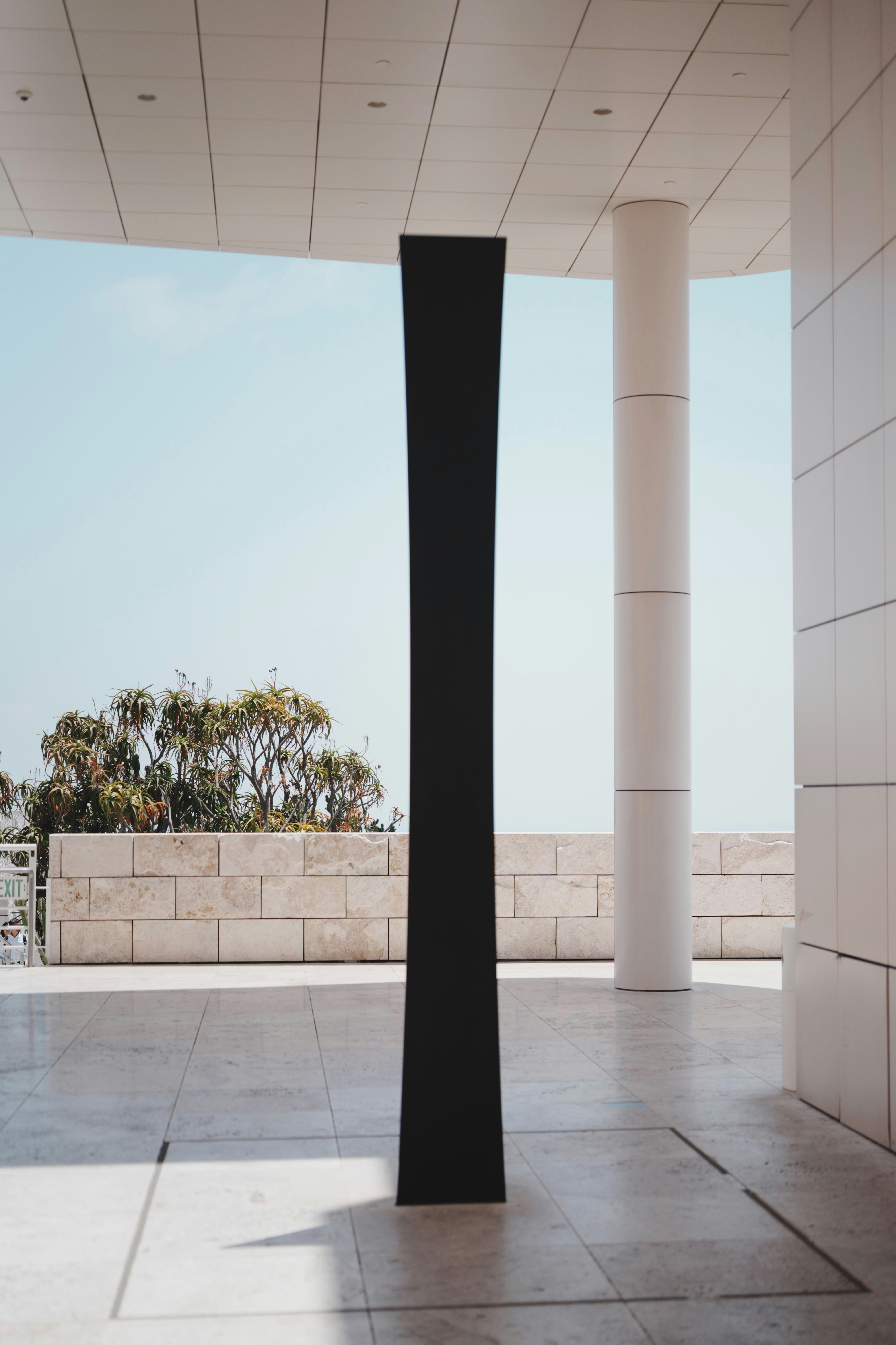Architectural Pillar Framed by Open Sky and Shadowed Corridor