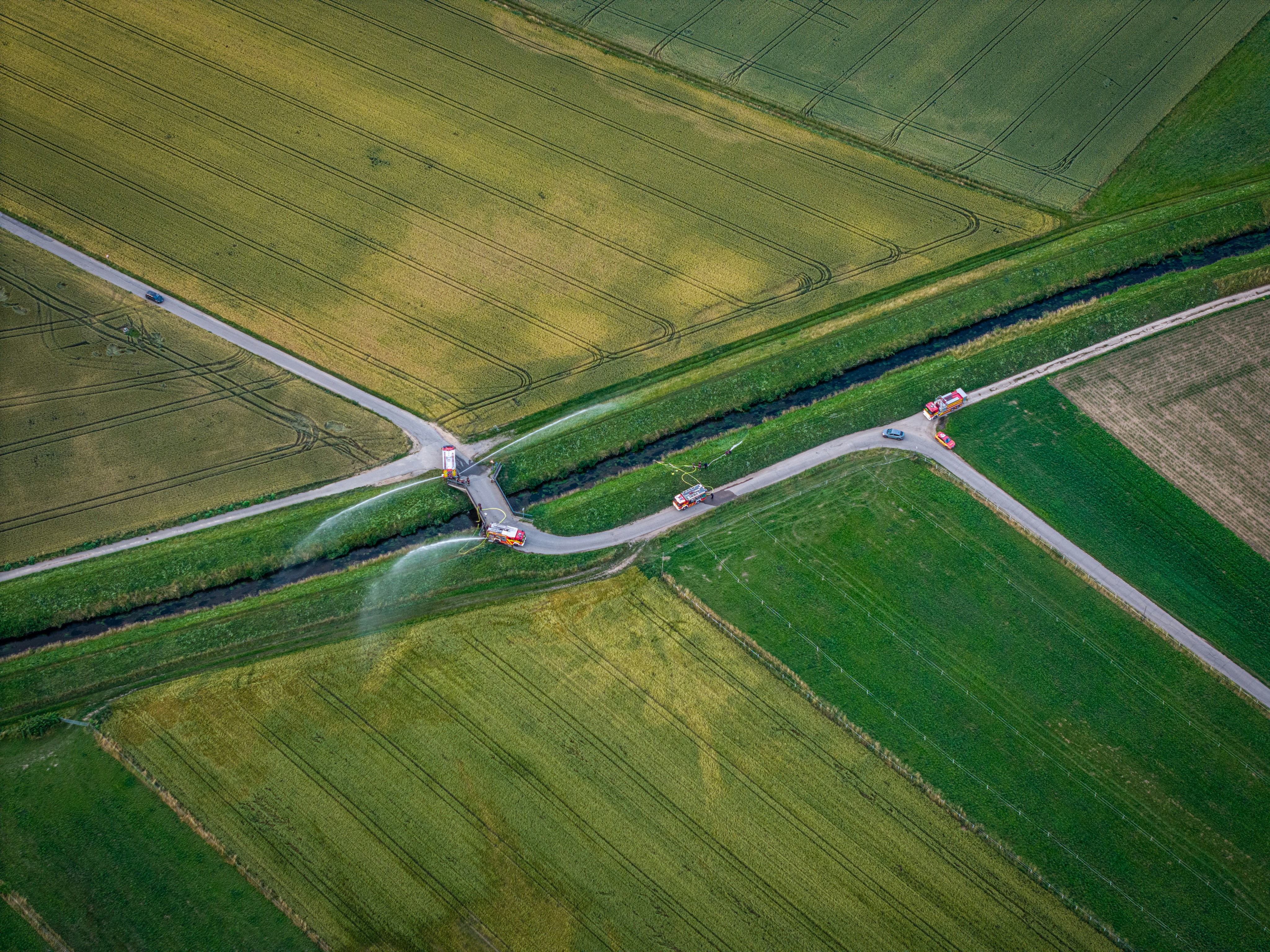 Crossroads Over Green Fields: Aerial Grid Meeting Along the Ditch