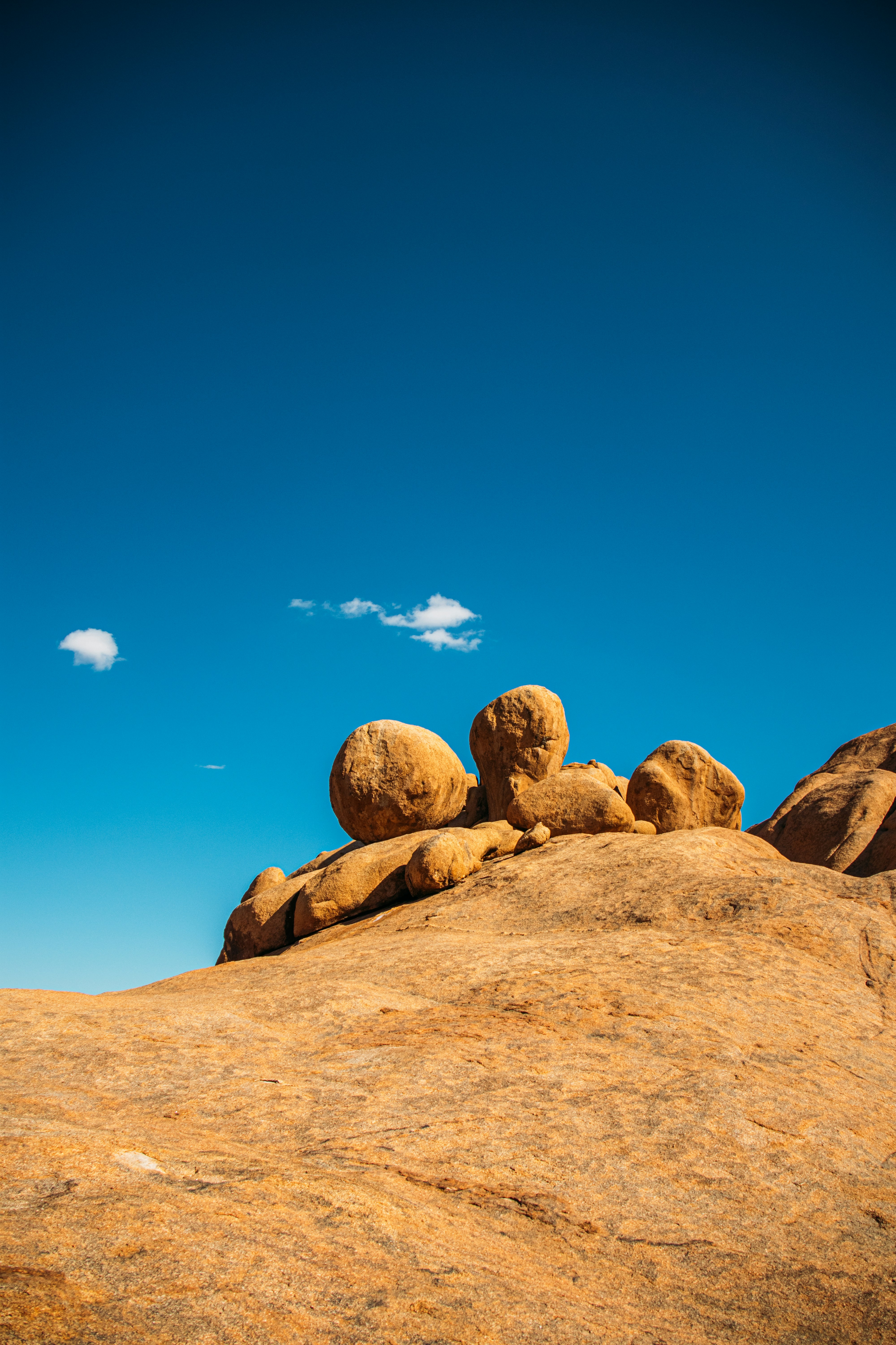 Massive rock formations under a clear blue sky.