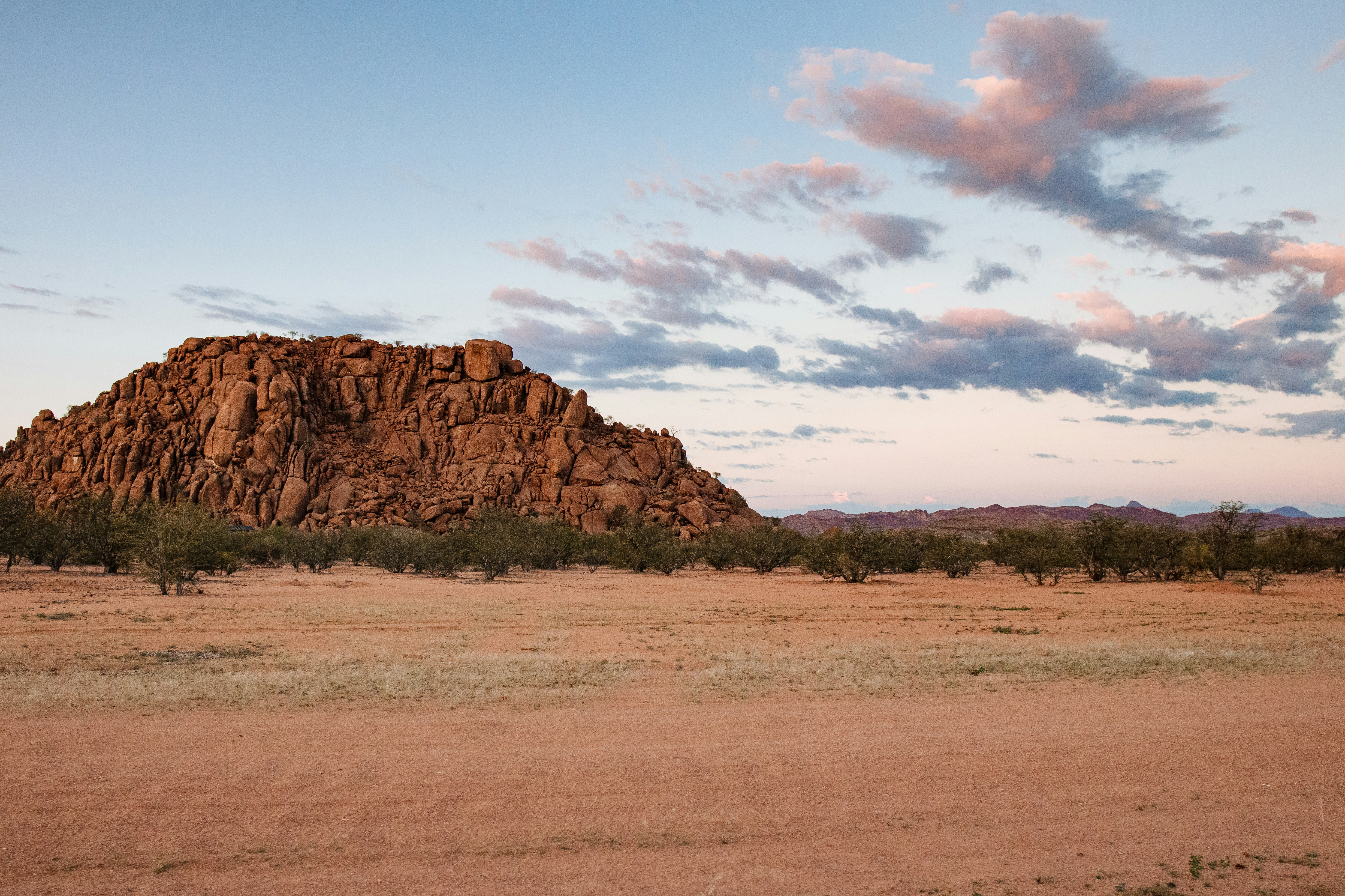 Desert Granite Slope Under a Cotton-Clouded Sky