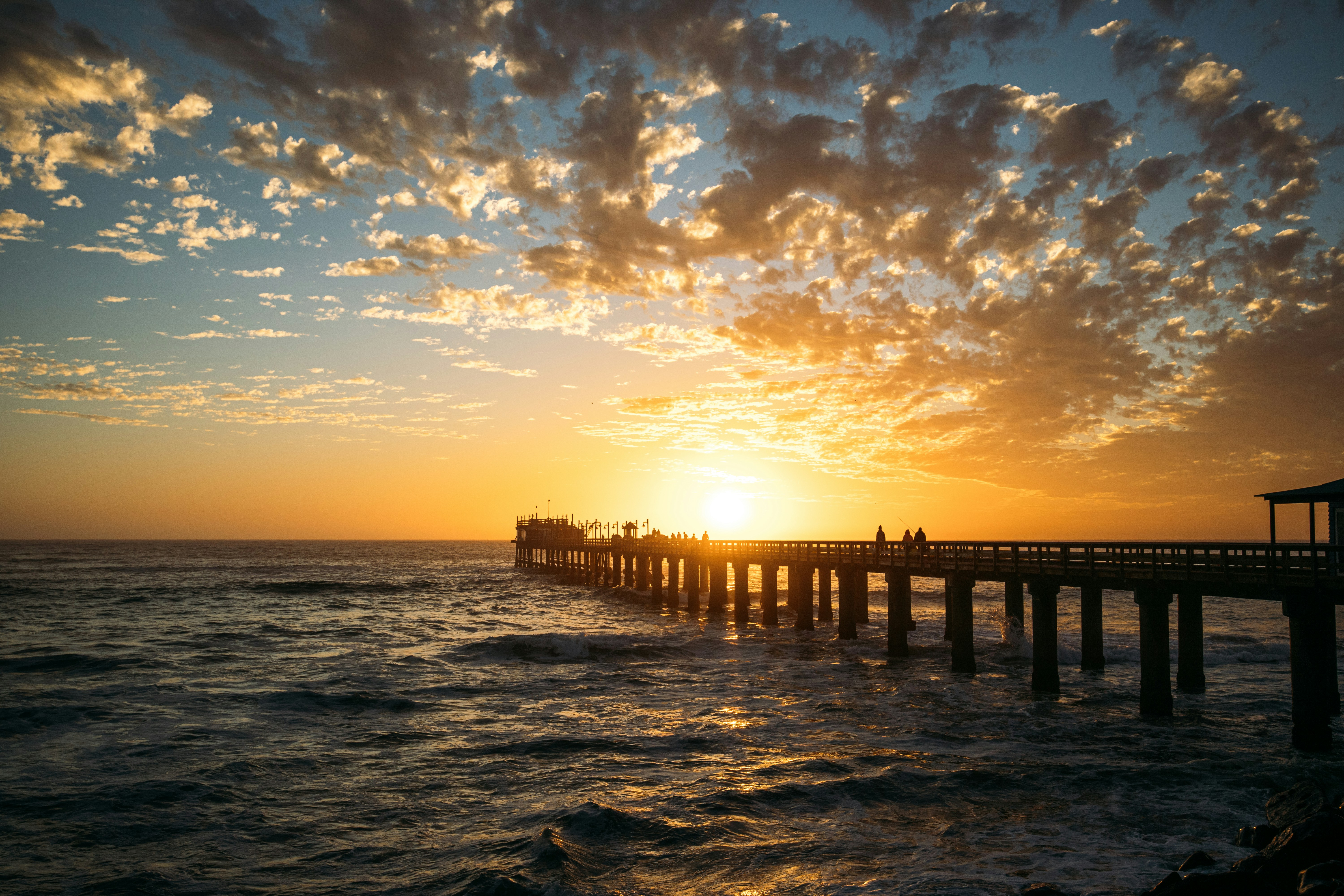 Sunlit Pier: A Stretched Horizon Over Quiet Seas