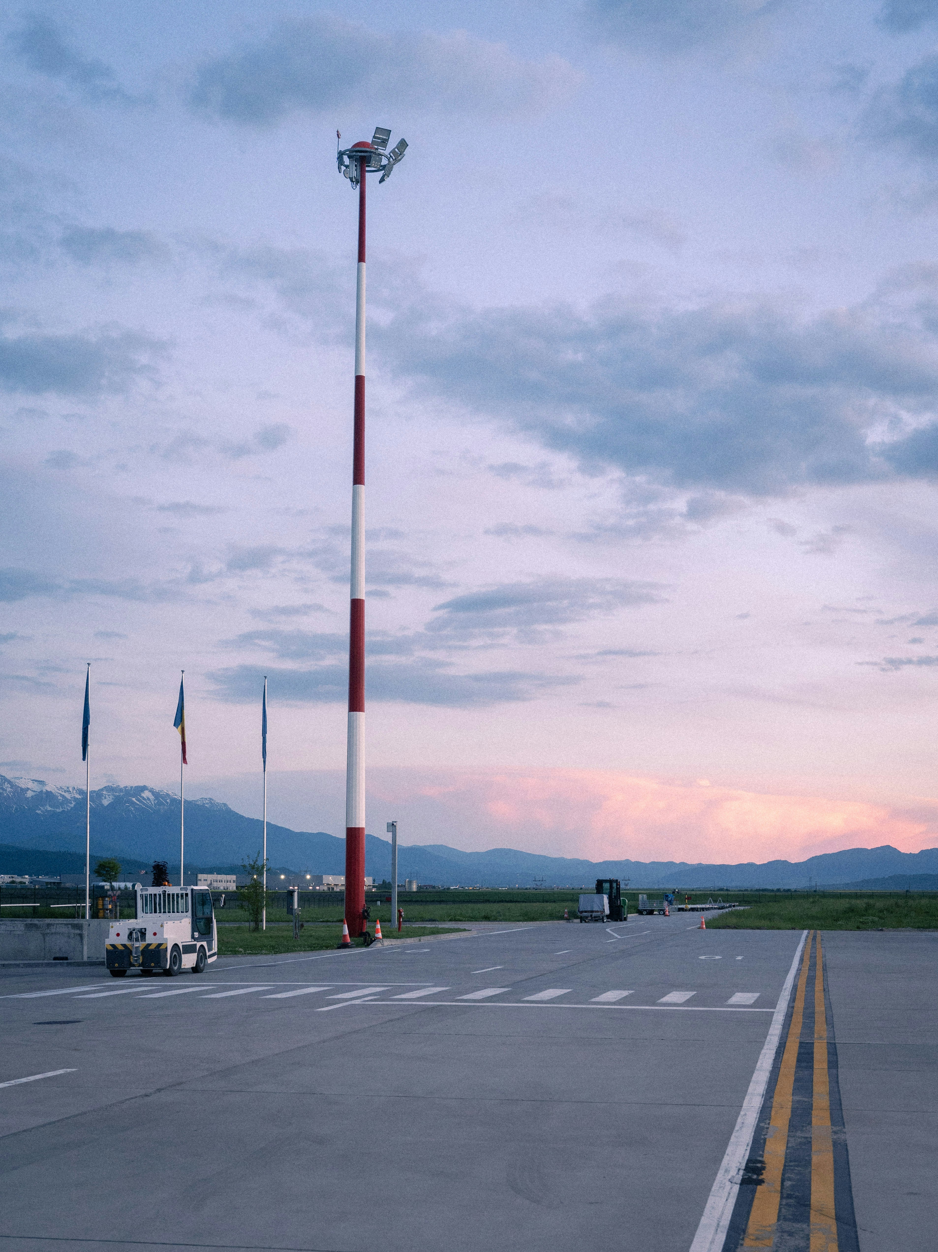 Runway Twilight: The Tall Beacon Over a Quiet Airport