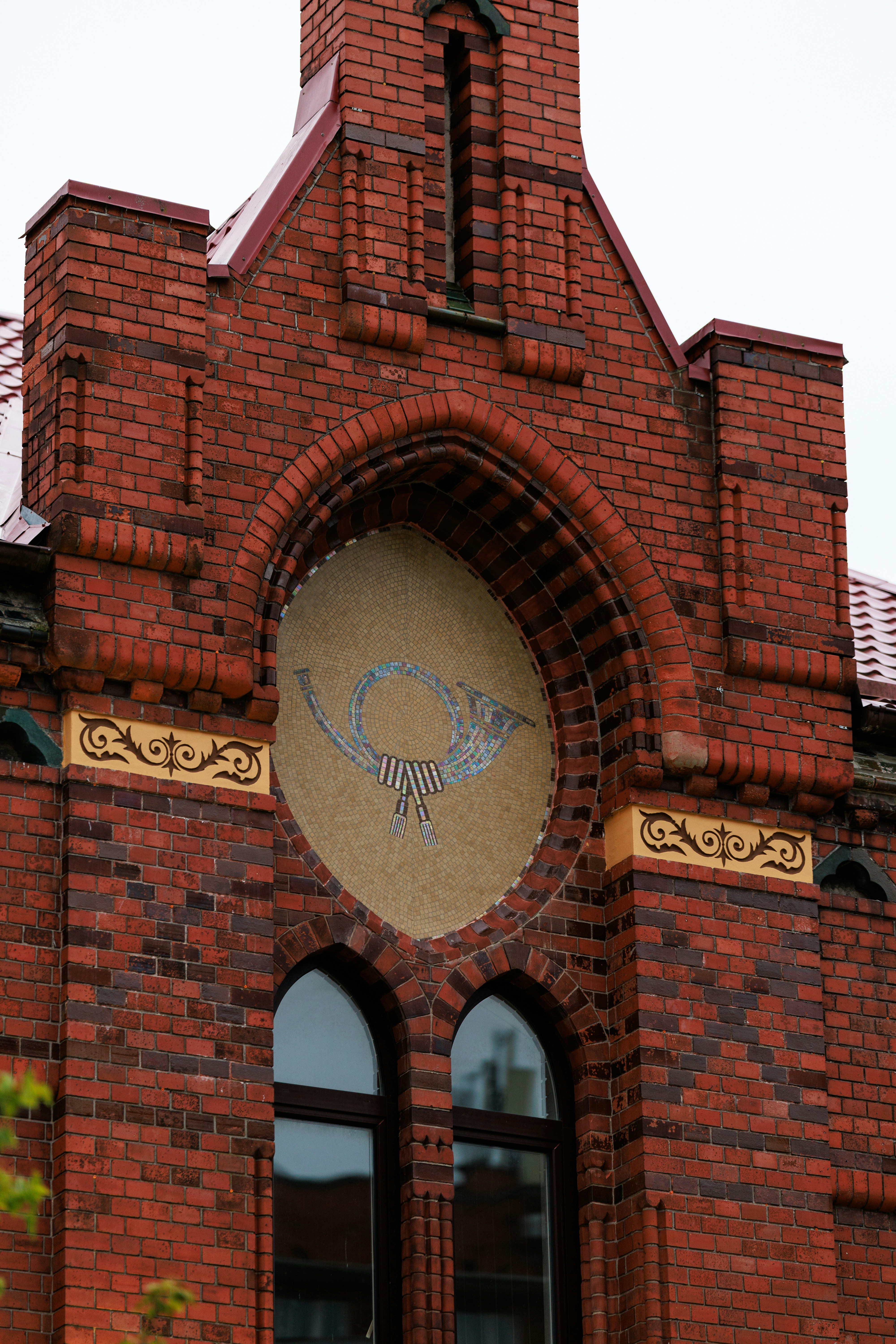 Brick Facade with Central Mosaic Rosette above Arched Windows