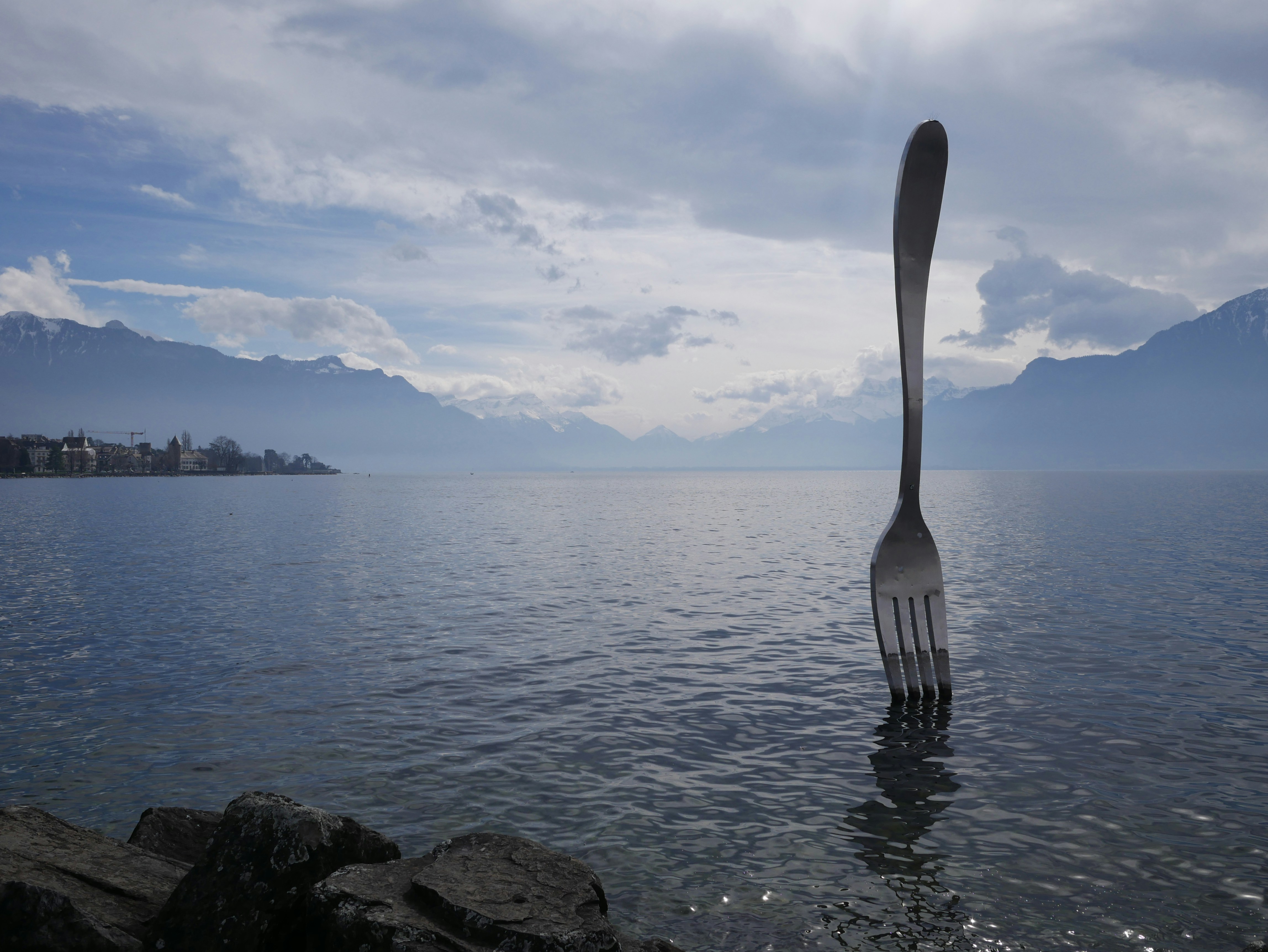 A Fork Elevates From Lake: Frosty Peaks and a Giant Spoon-shaped Shadow