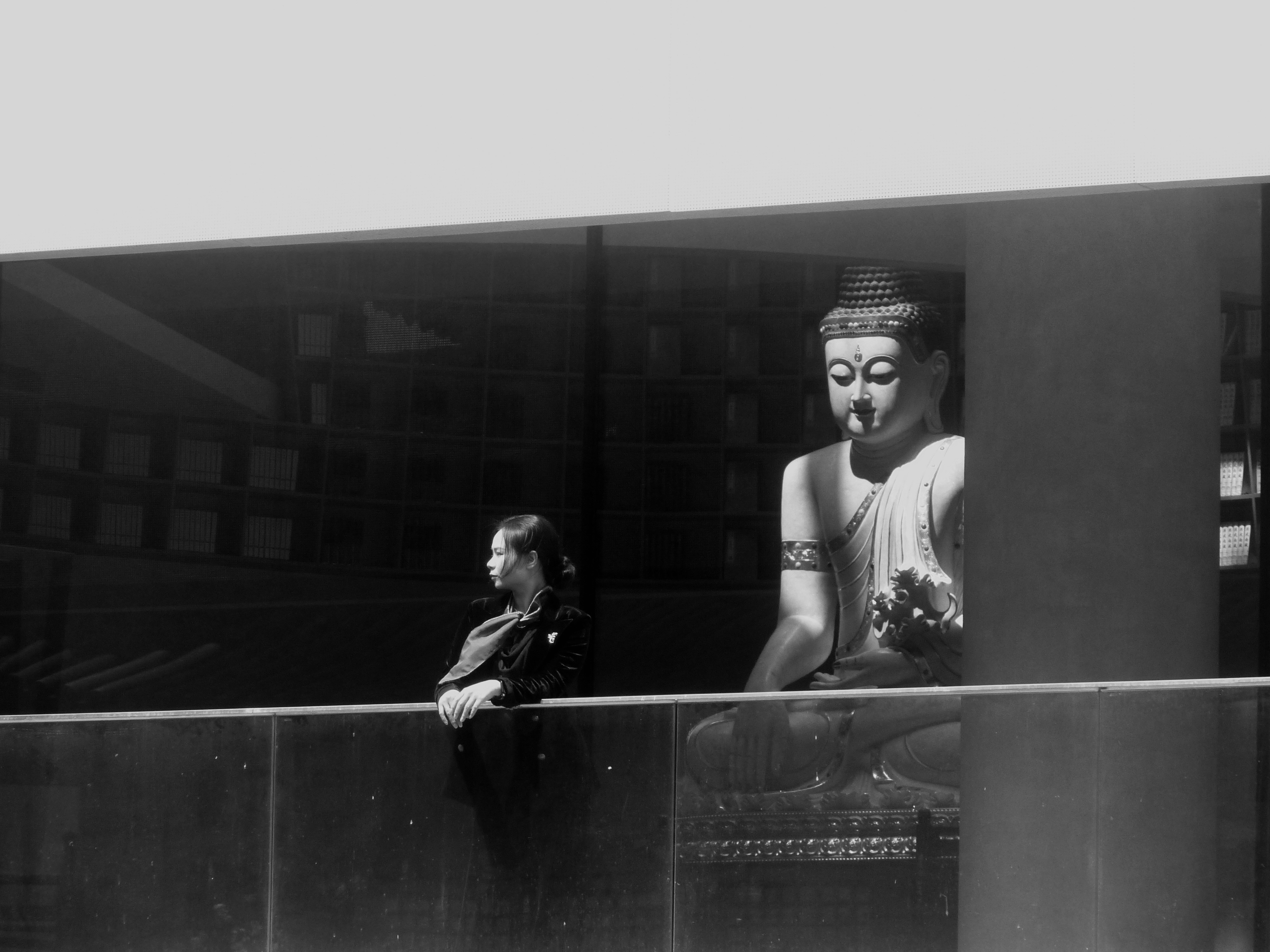Quiet Portrait by the Buddha: A Modern Observer in Frame