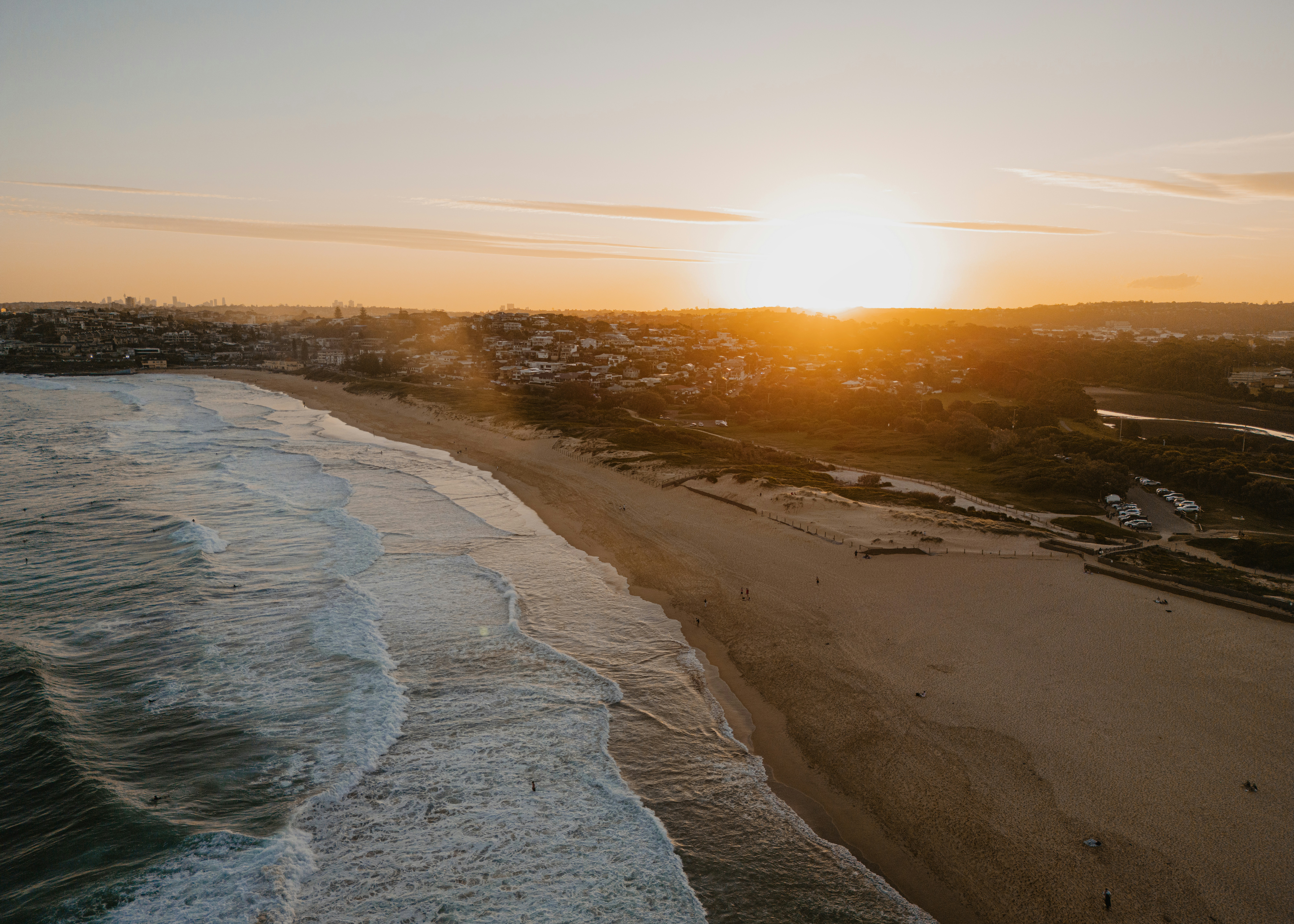 Sunlit Shoreline: A Dusk-Soft Horizon over Quiet Beach Town