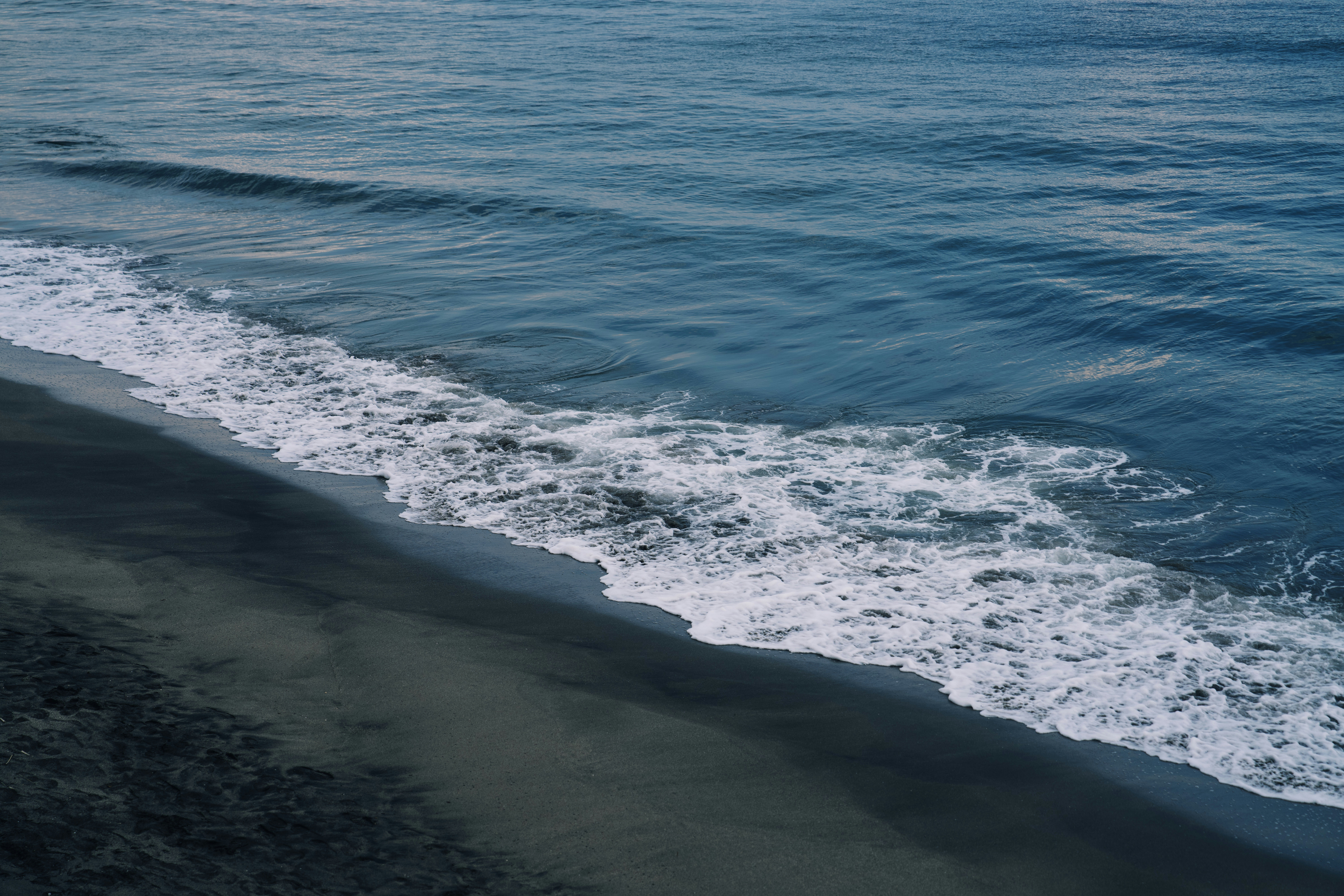 Coastal edge: Aerial view of breaking waves at a quiet shoreline