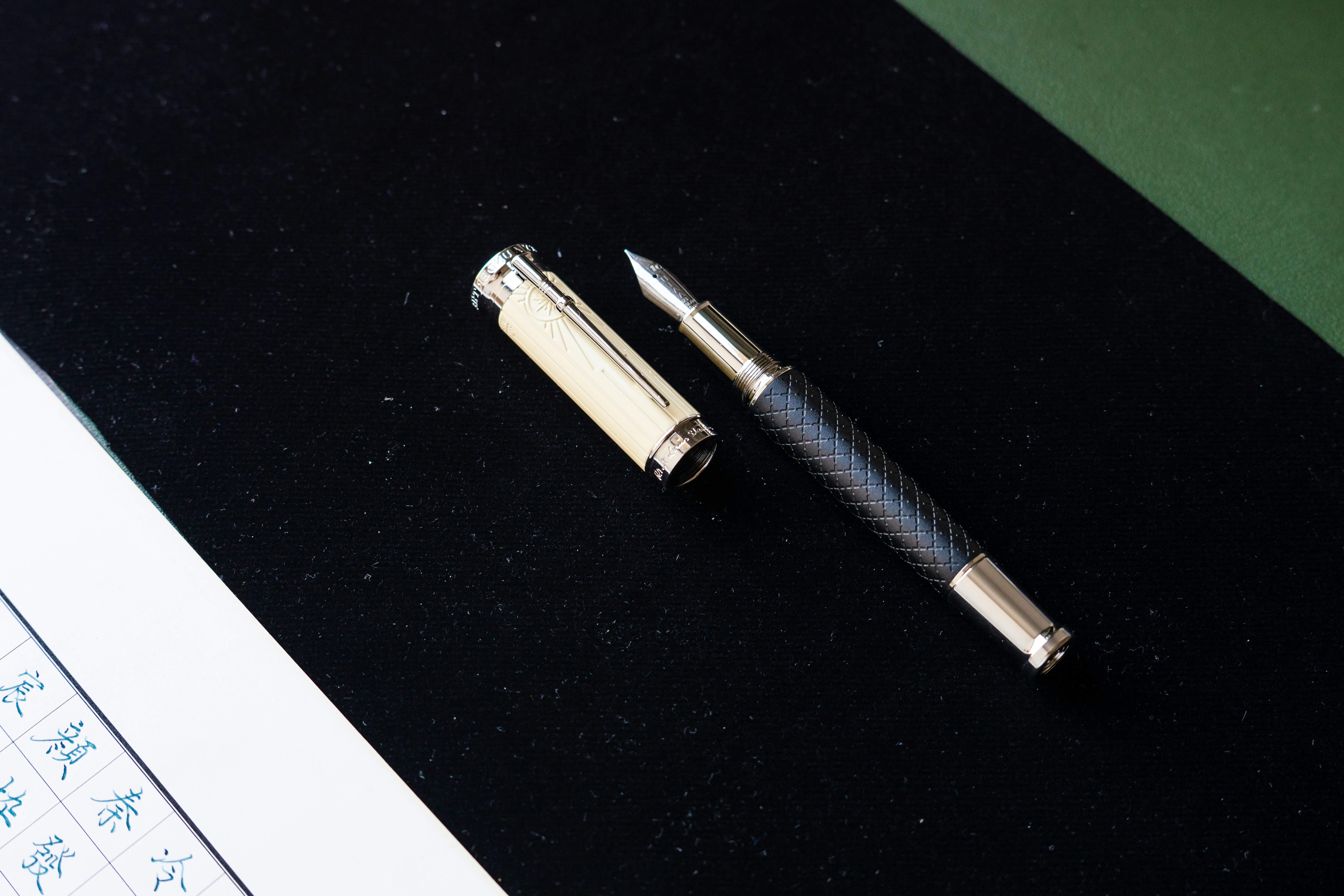 Disassembled connector resting on a speckled desk near a sheet of paper