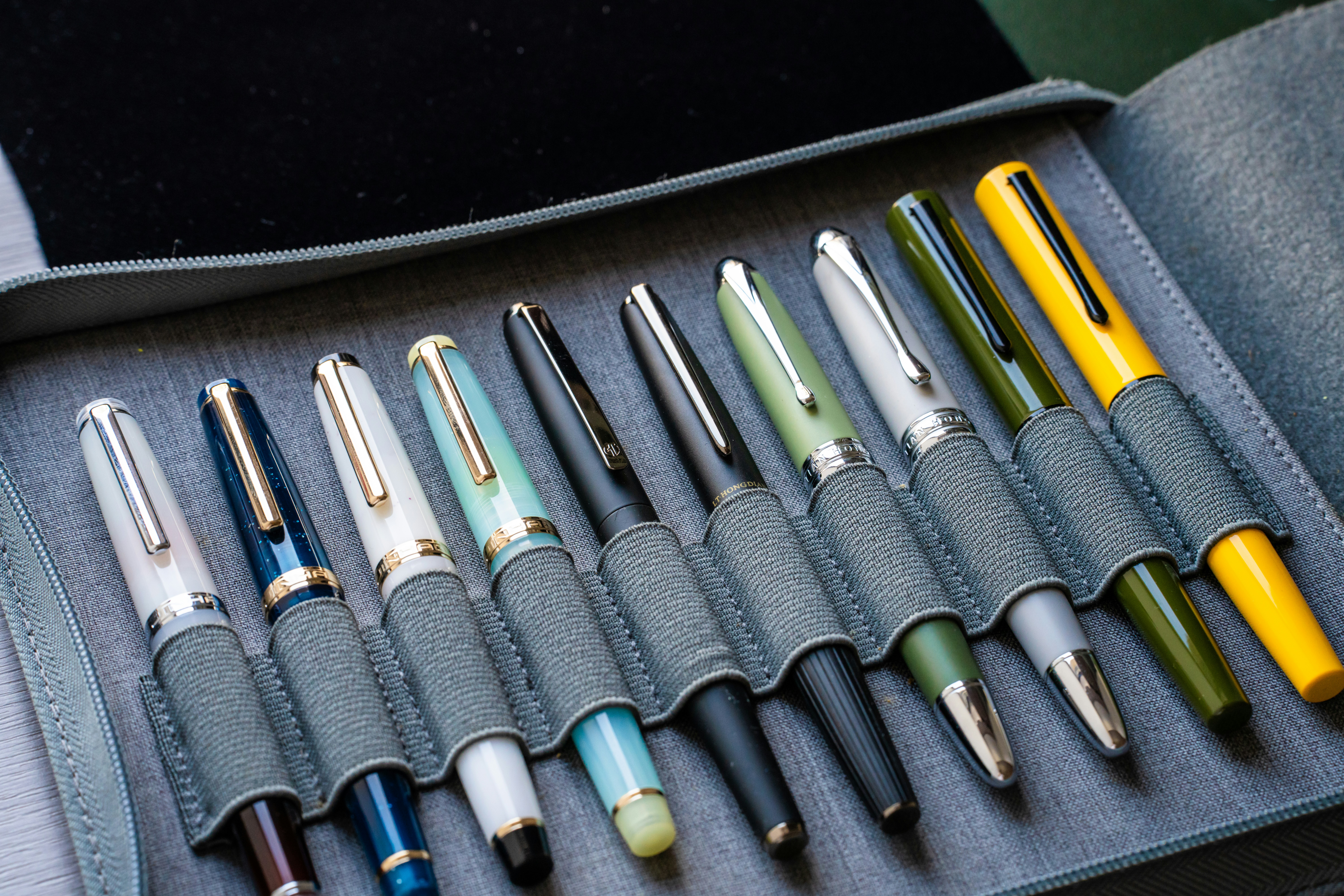 A Row of Elegant Fountain Pens in a Leather Pen Slotted Case