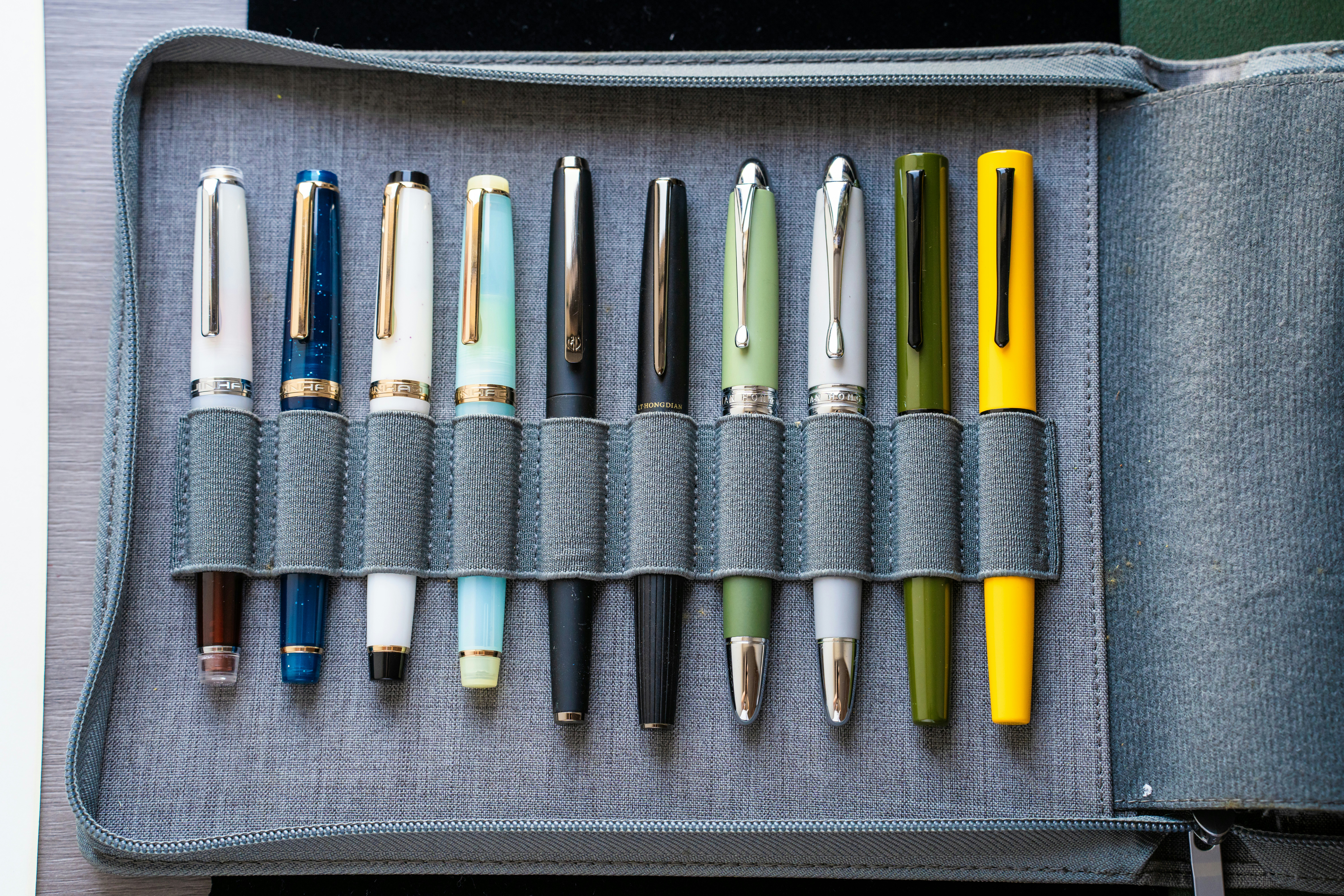 A Row of Enameled Pens in a Compact Travel Case
