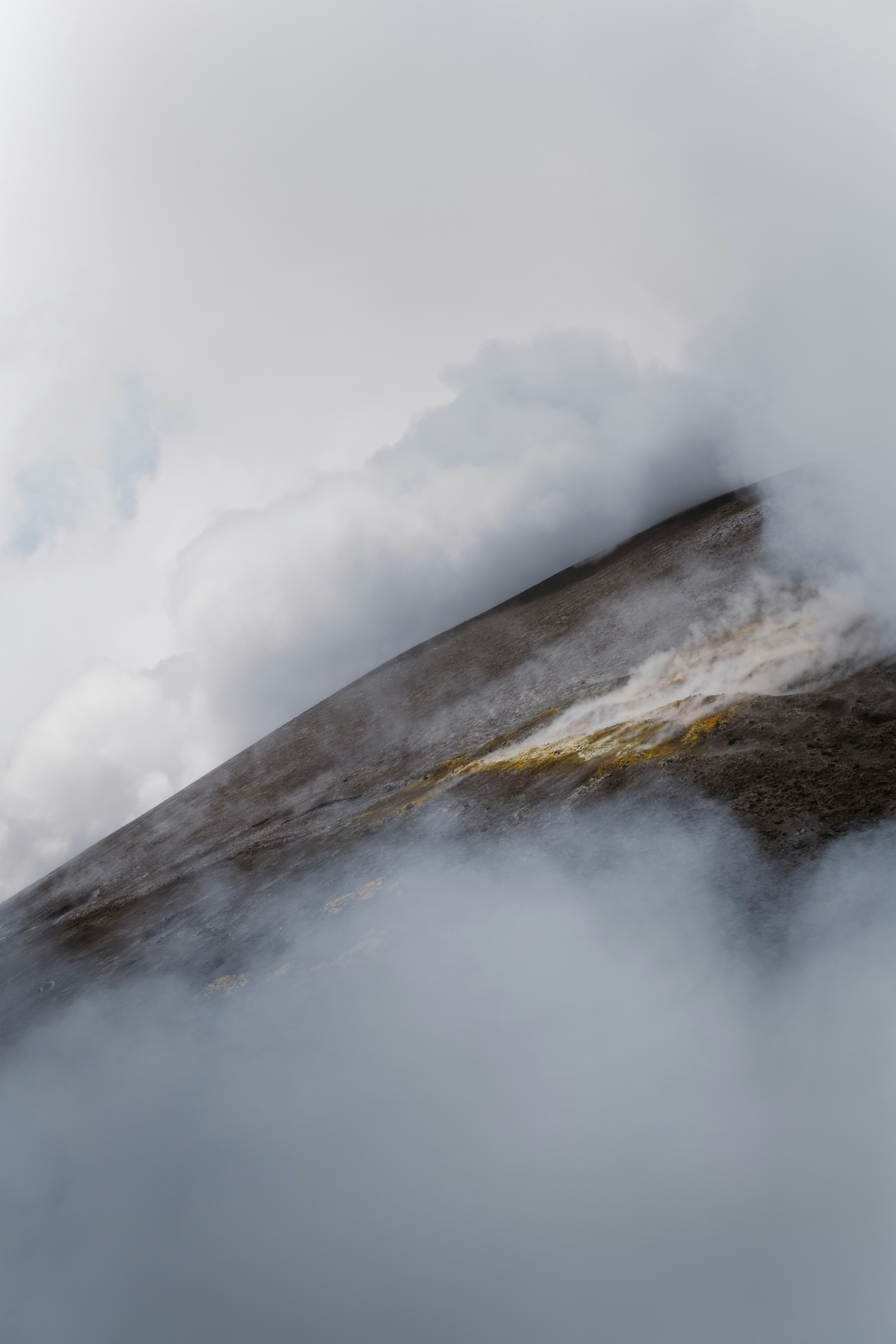 Misty Summit: A Slanted Vein of Steam in Quiet Volcano