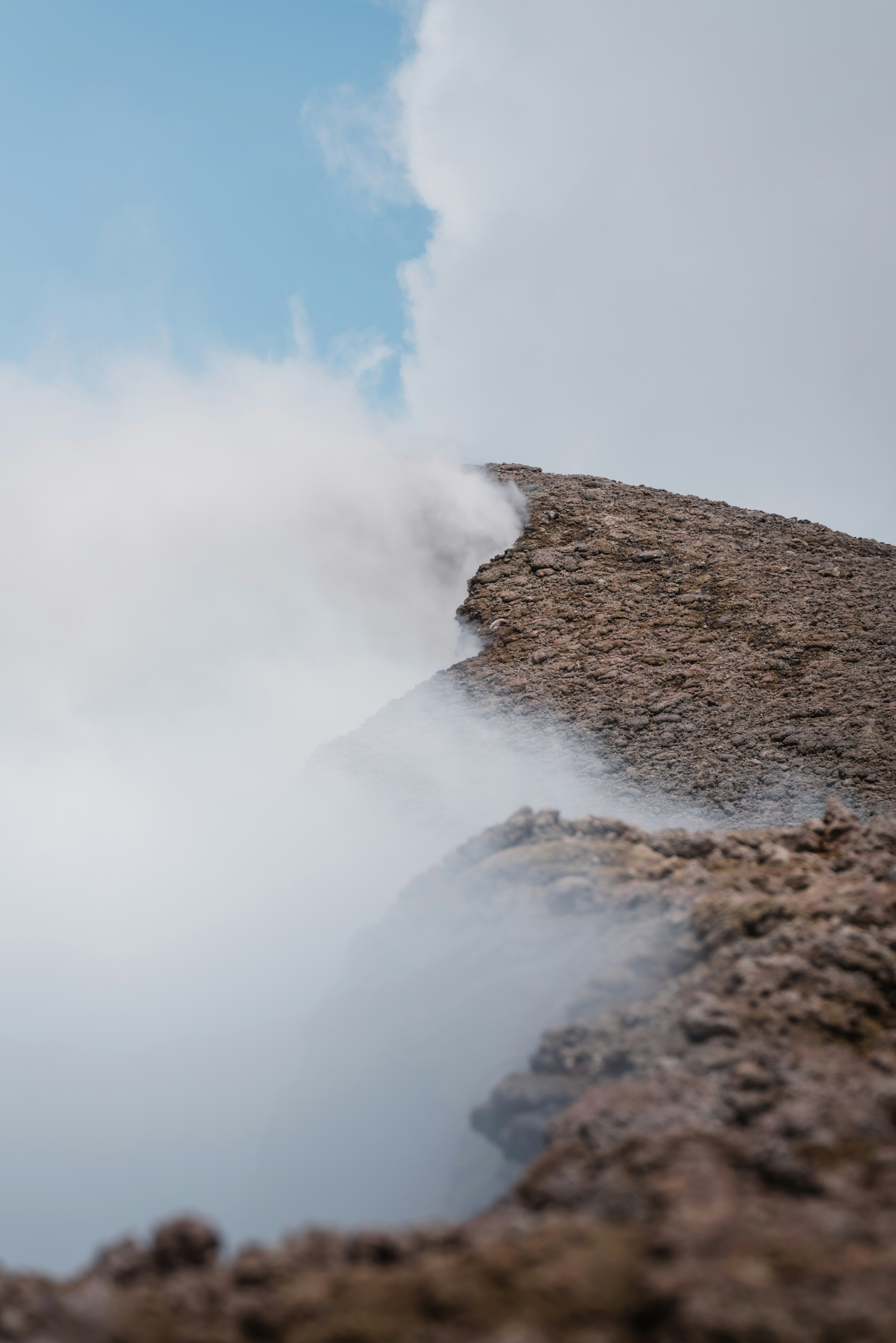 Ridge of Steam: A Cloudy Rim Over Rugged Terrain