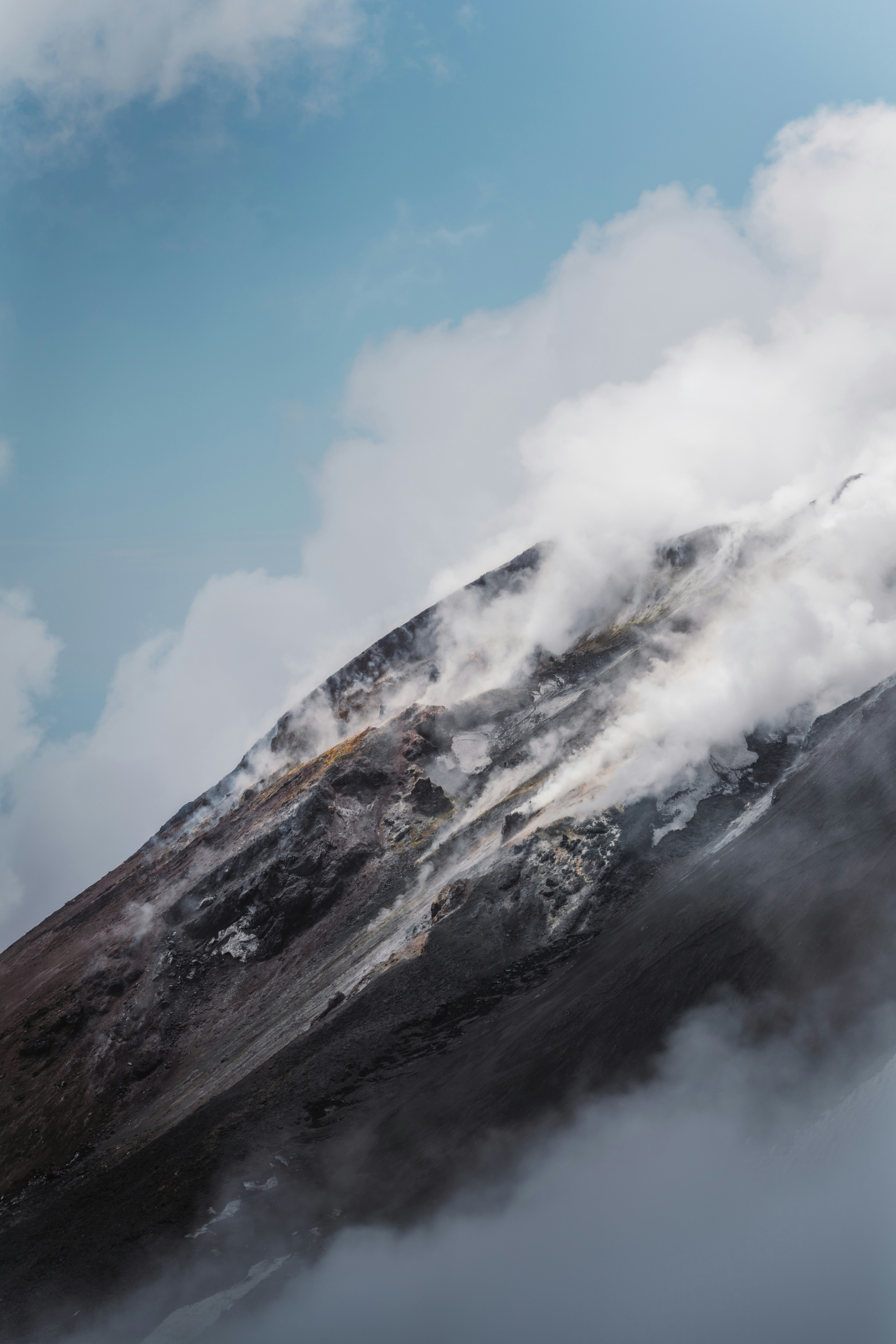 Misty Peak: A Snow-Covered Ridge Breaking into the Clouds