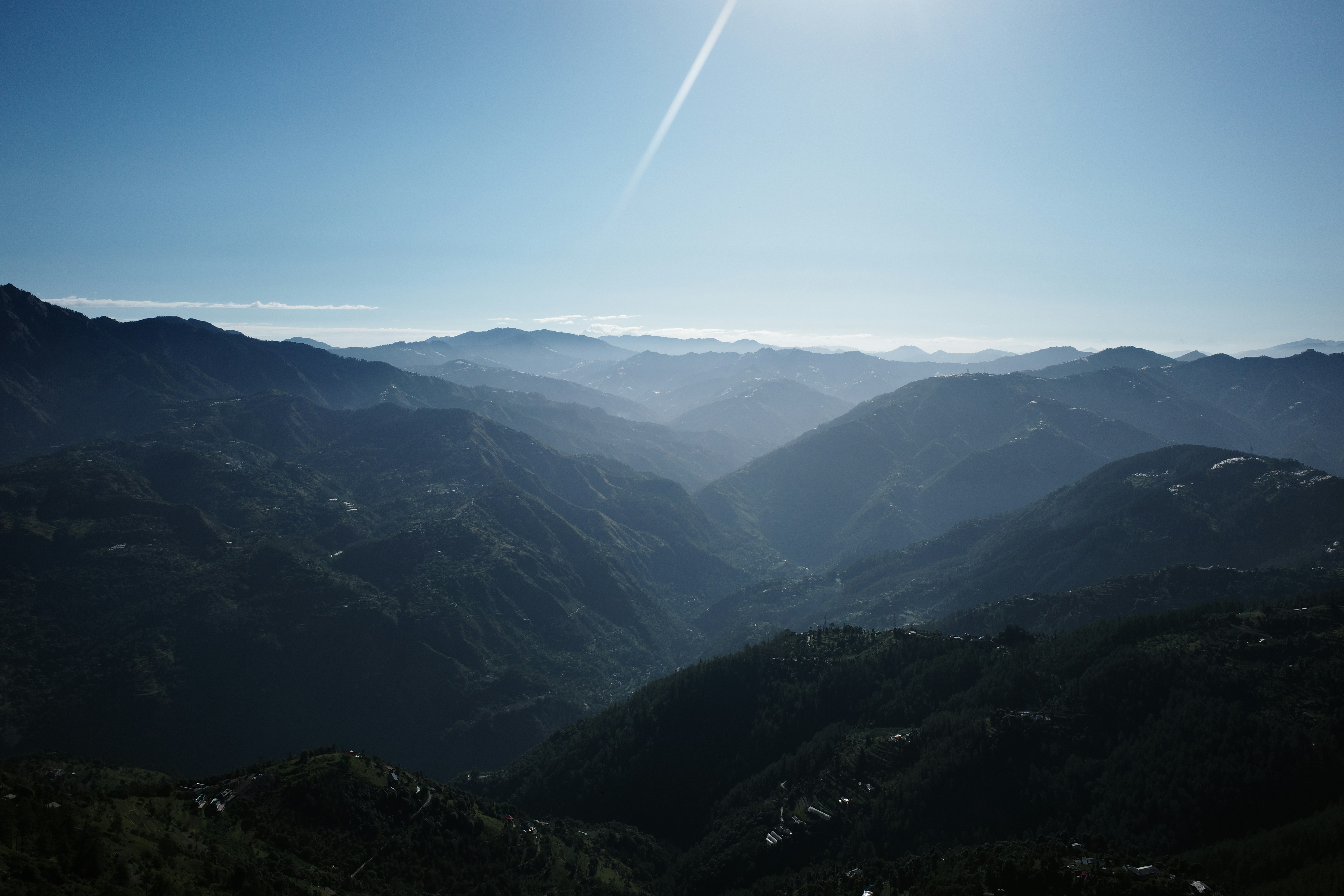 Mist-Laced Valleys Under a Clear Cascade of Light