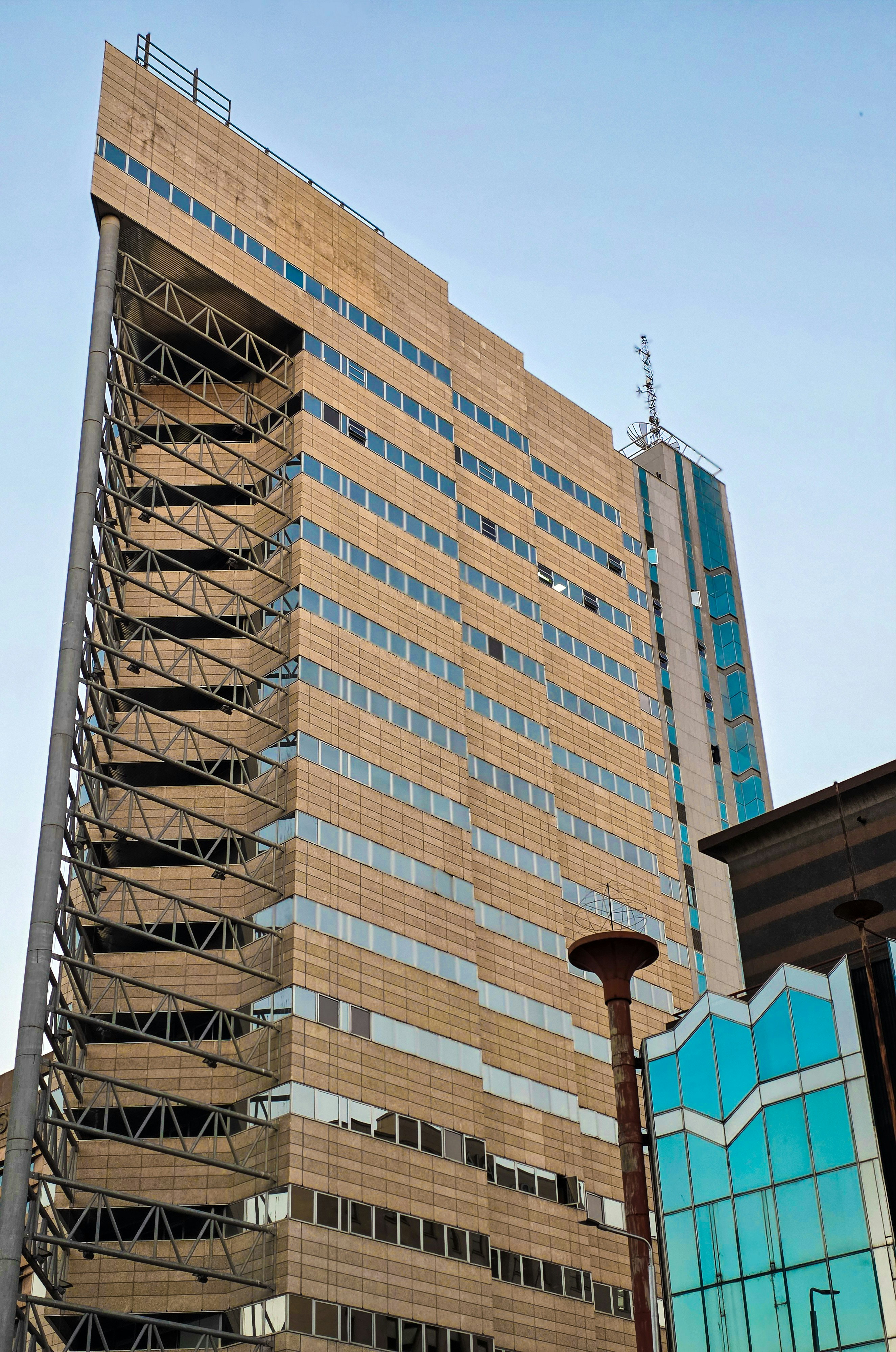 Terraced Skyscraper: Steel Staircase Silhouette Against a Breezy Blue