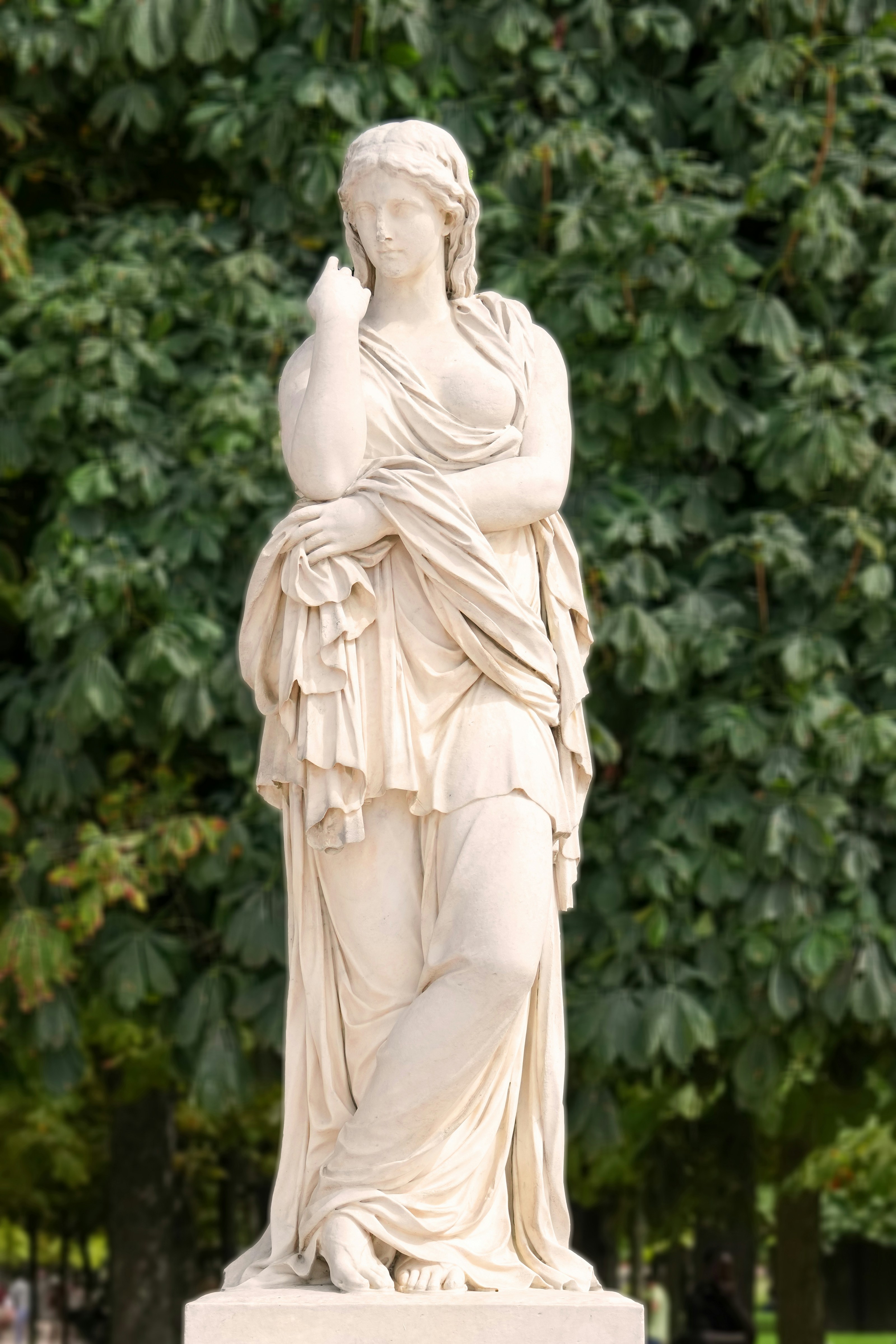 Whispered Contemplation: Marble Figure in Green Sanctuary