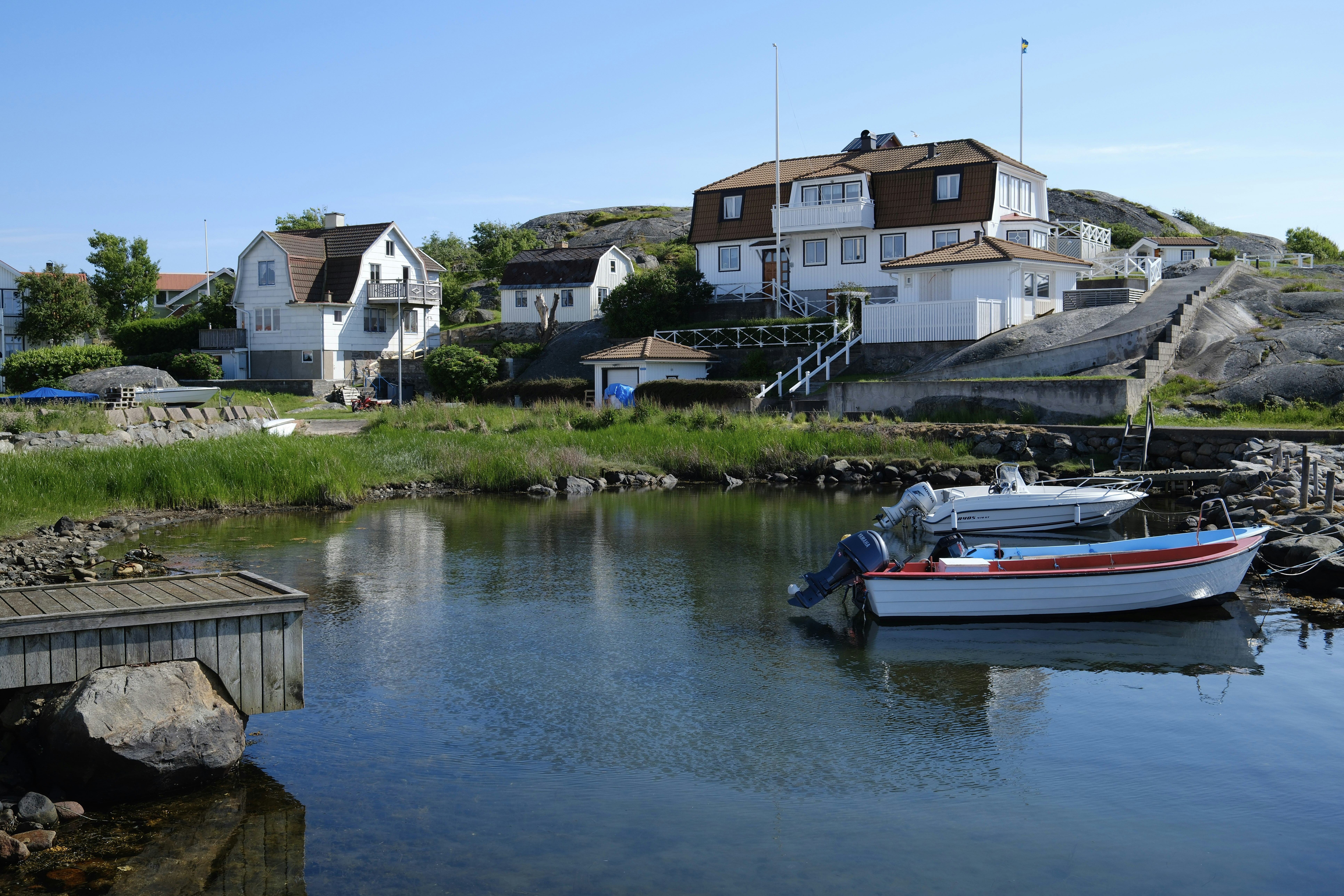 Harbor Houses and Small Boat at Quiet Tide