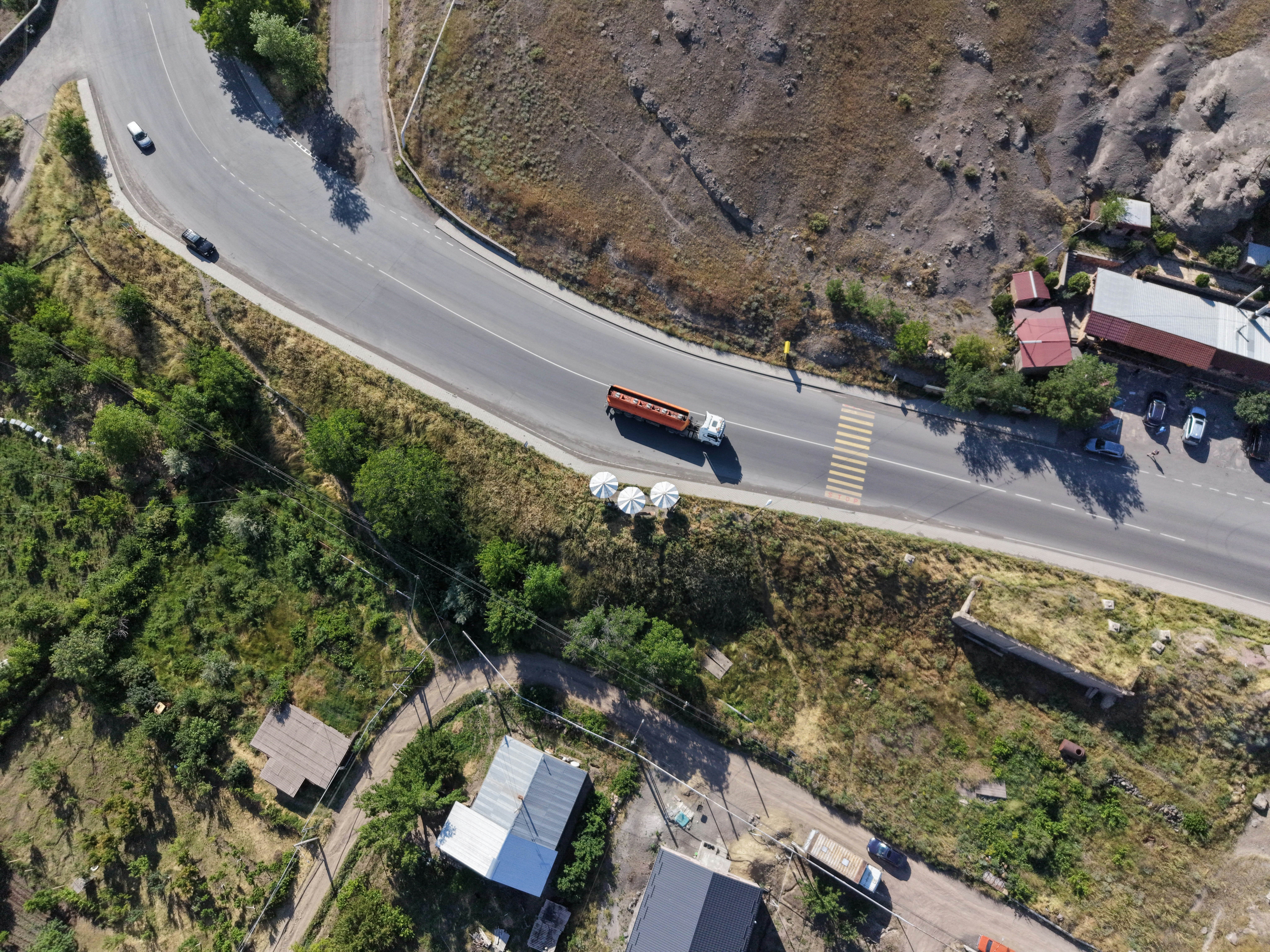 Curved Mountain Road: Aerial Quiet with Vehicle in Transit