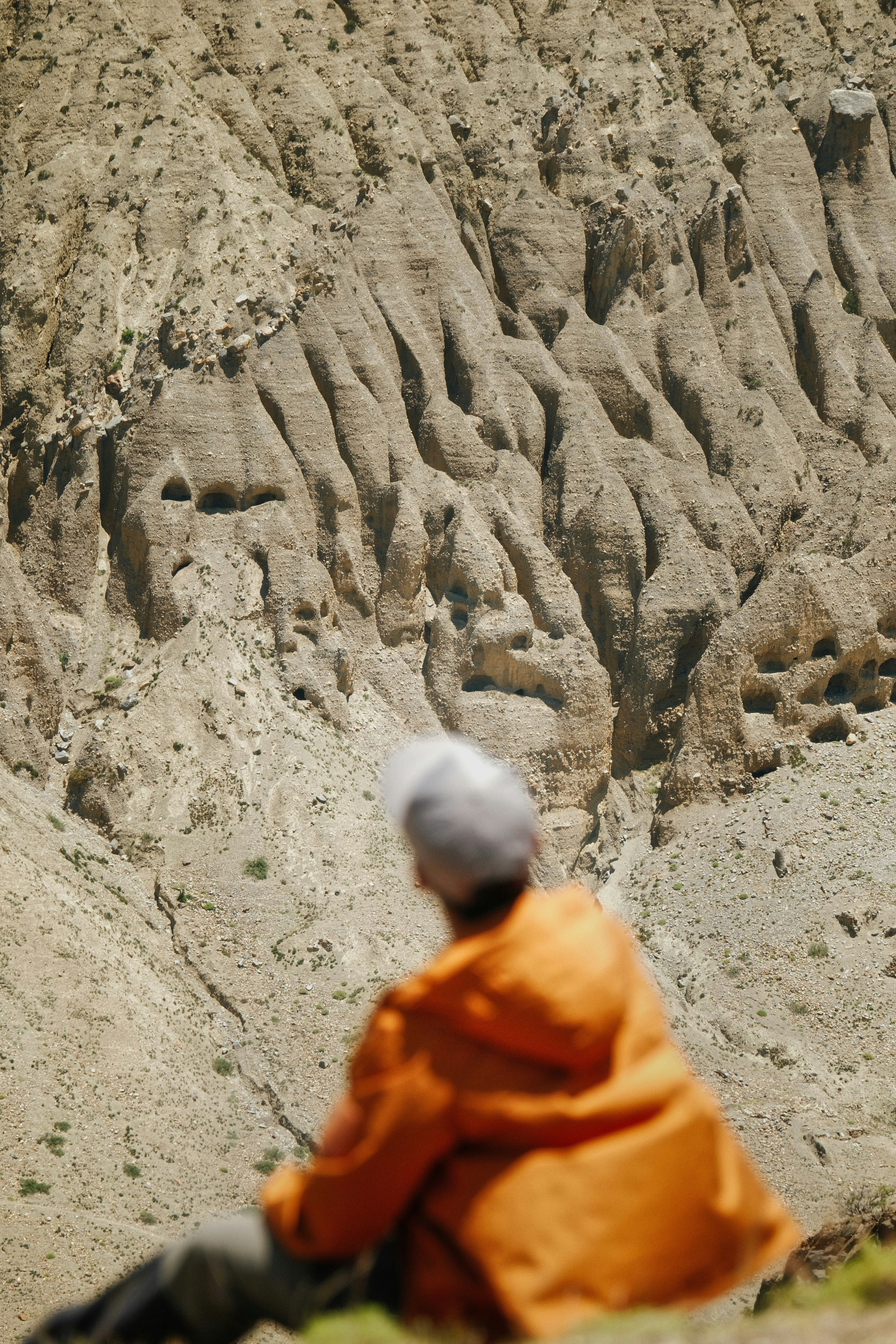 Blurry Traveler Amid Eroded Cliffs