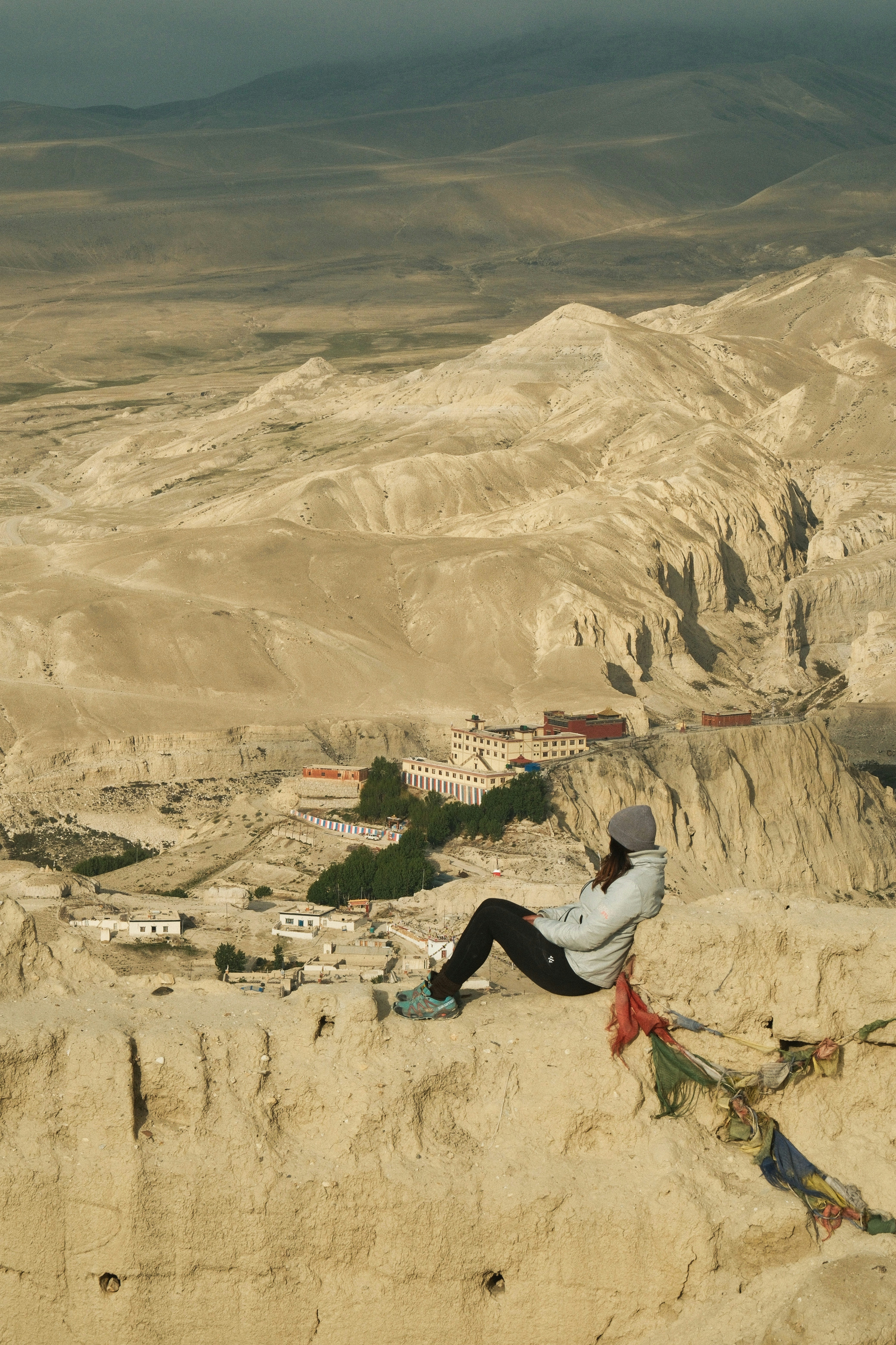 Cliffside Rest: A Lone Traveler Amidst Eroded Valleys