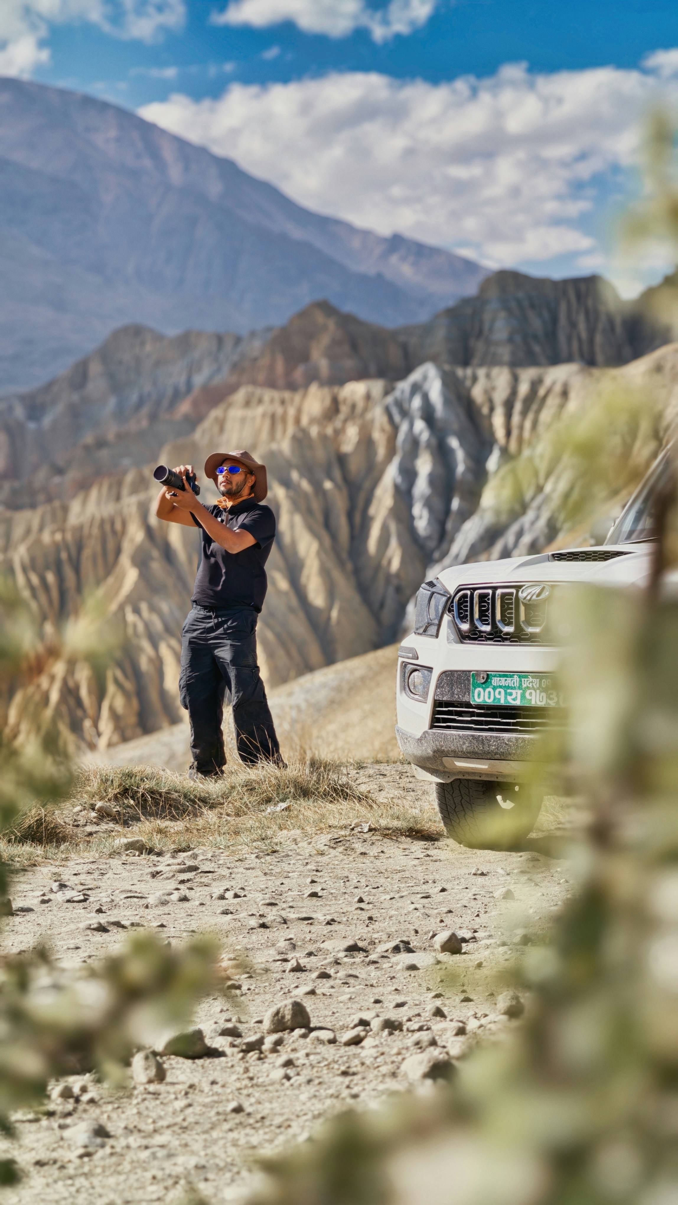 Rugged Landscape Photographer in the Shadow of a Truck