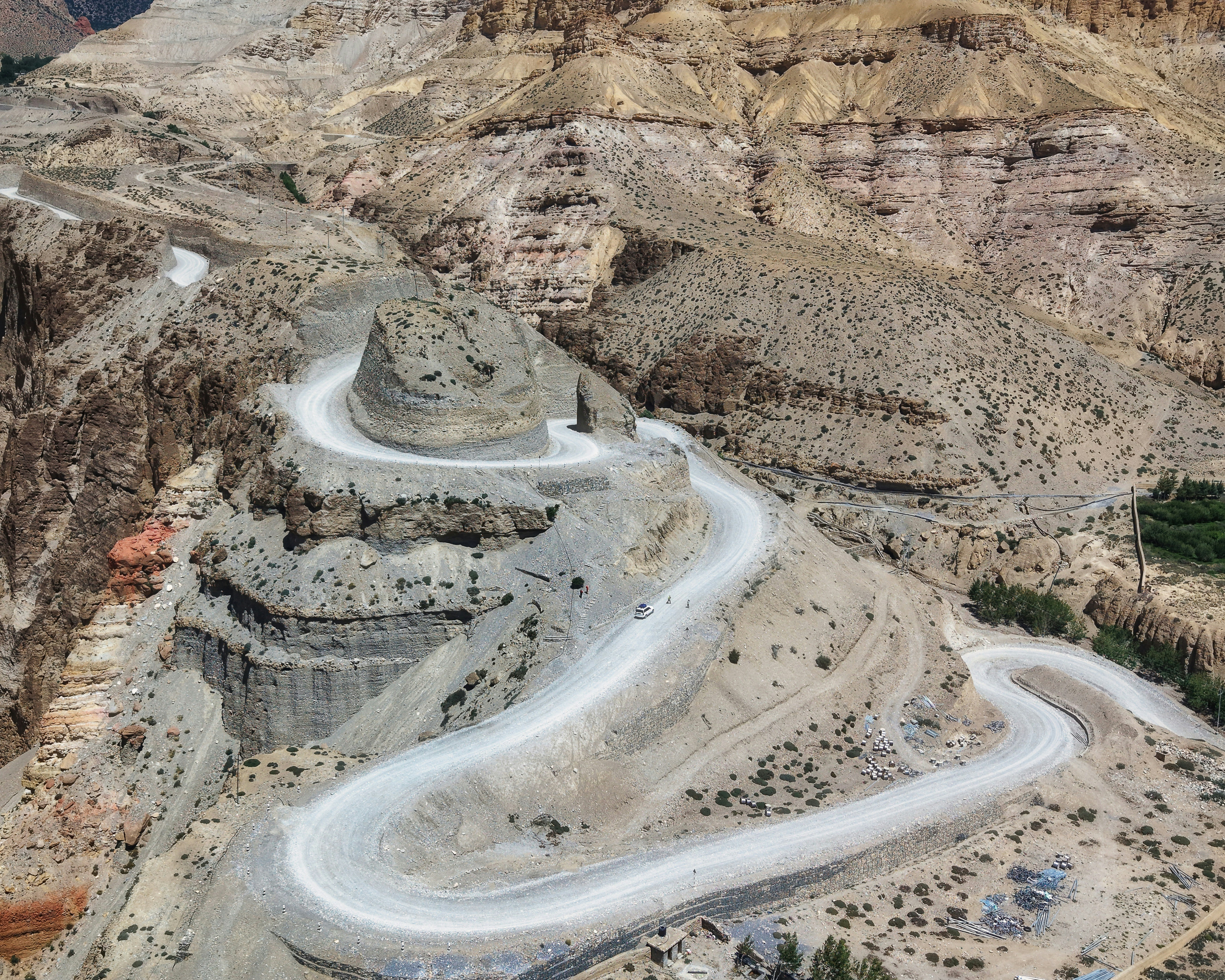 Serpentine Road Through Arid Cliffs: A Meandering Cut into Sedimentary Echoes