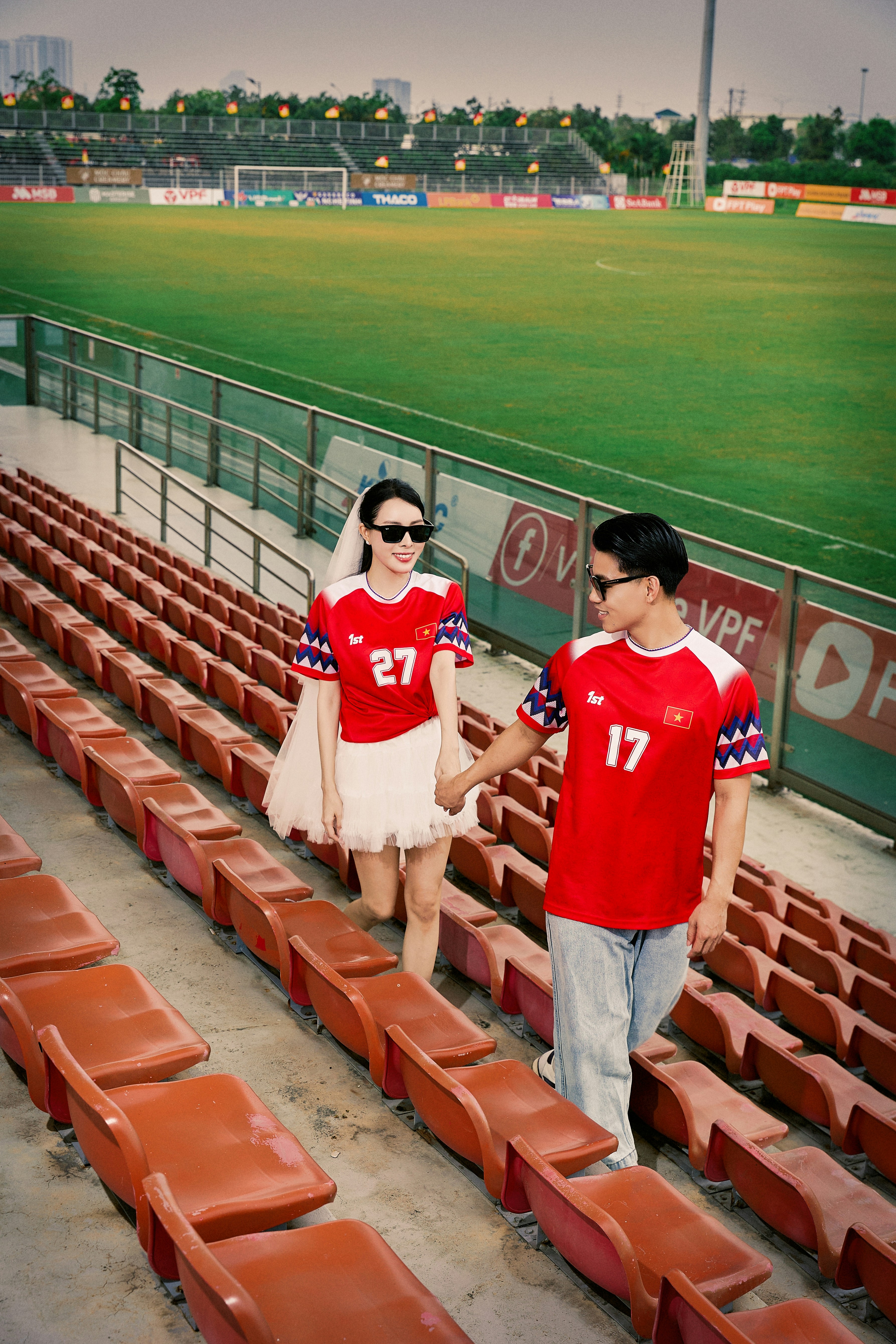 Couple in Red Jerseys Ascend the Stadium Steps