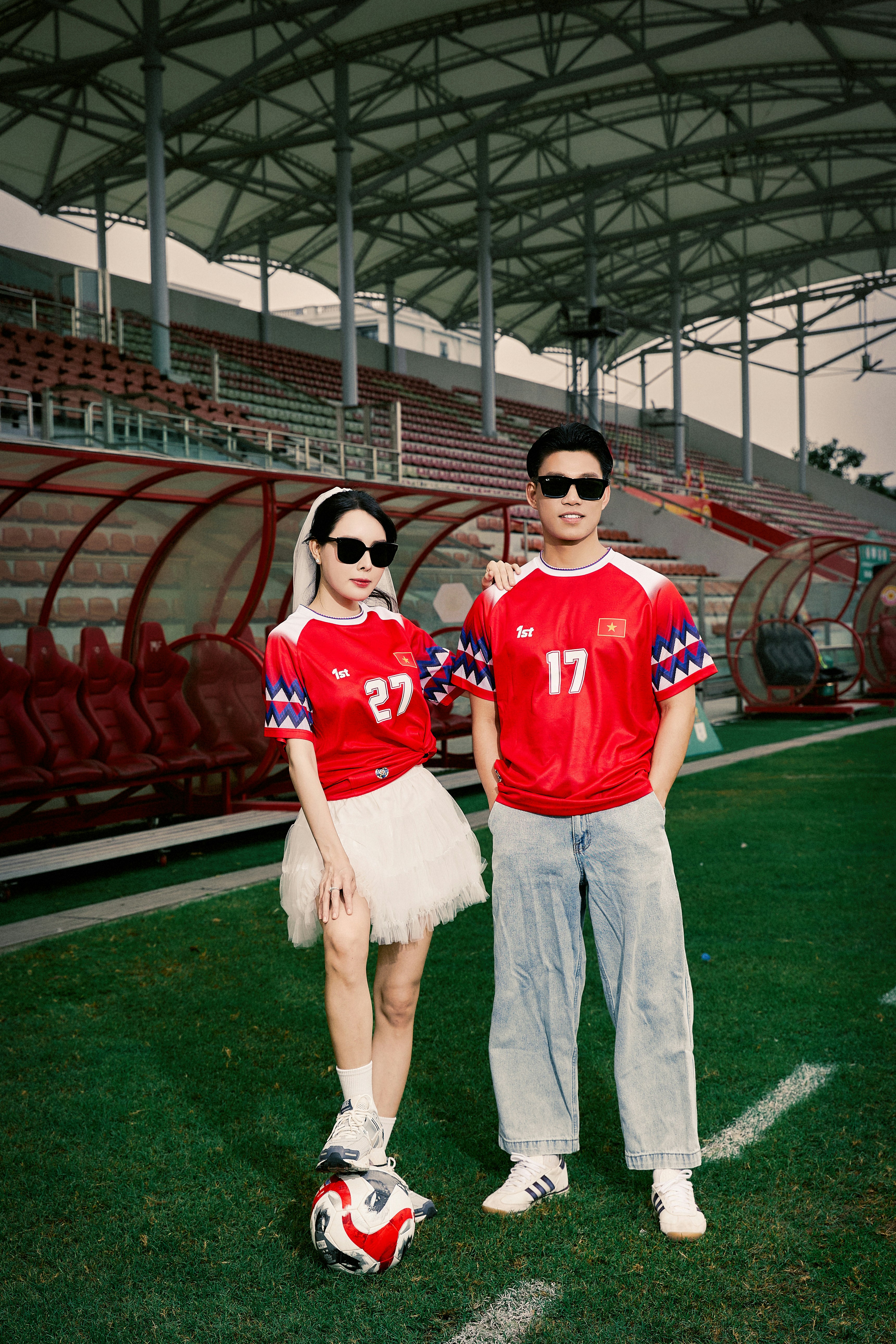 Red Kits, Green Field: A Duo Stance at the Stadium Edge