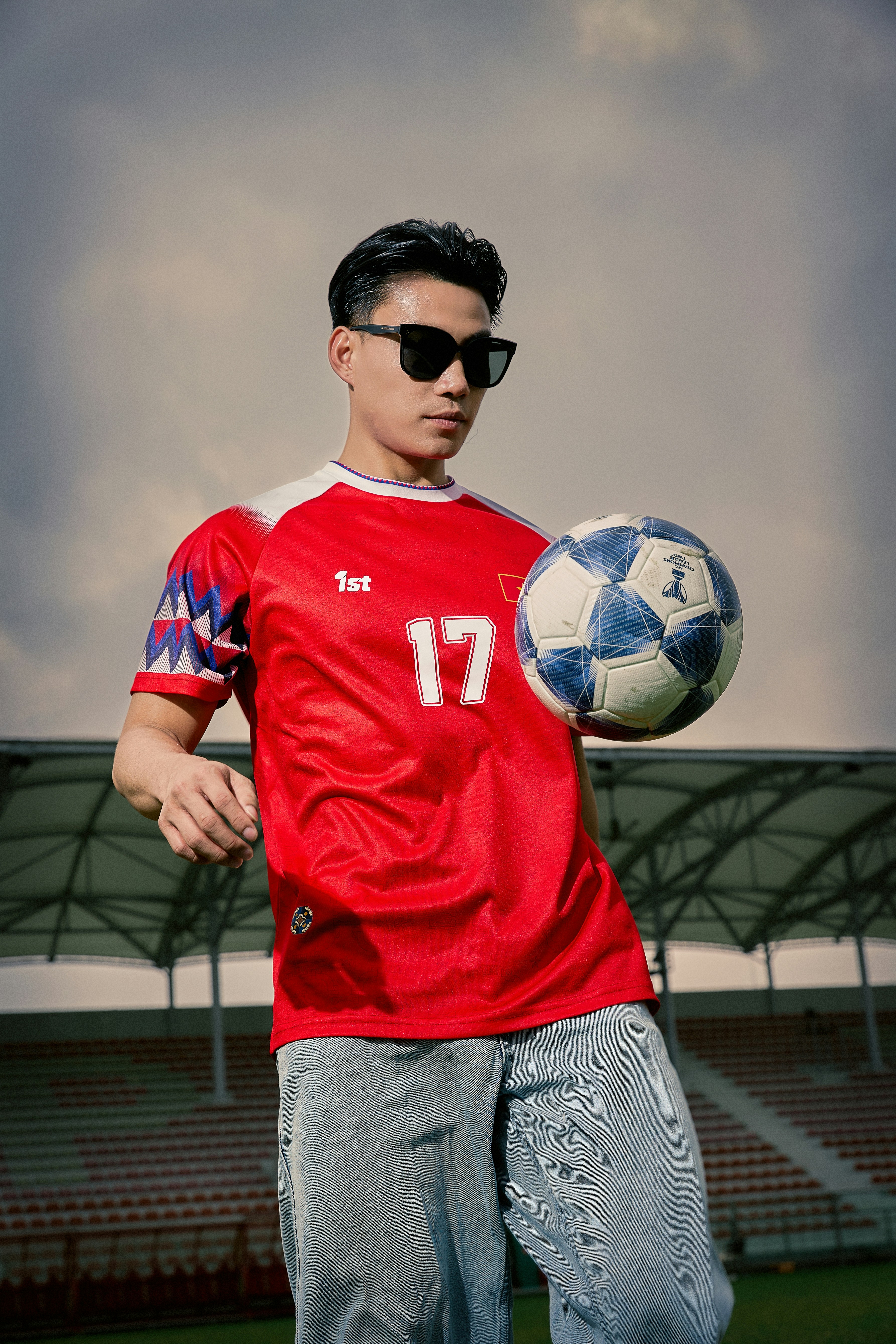 Red jersey, blue soccer ball: a focused portrait on a young athlete