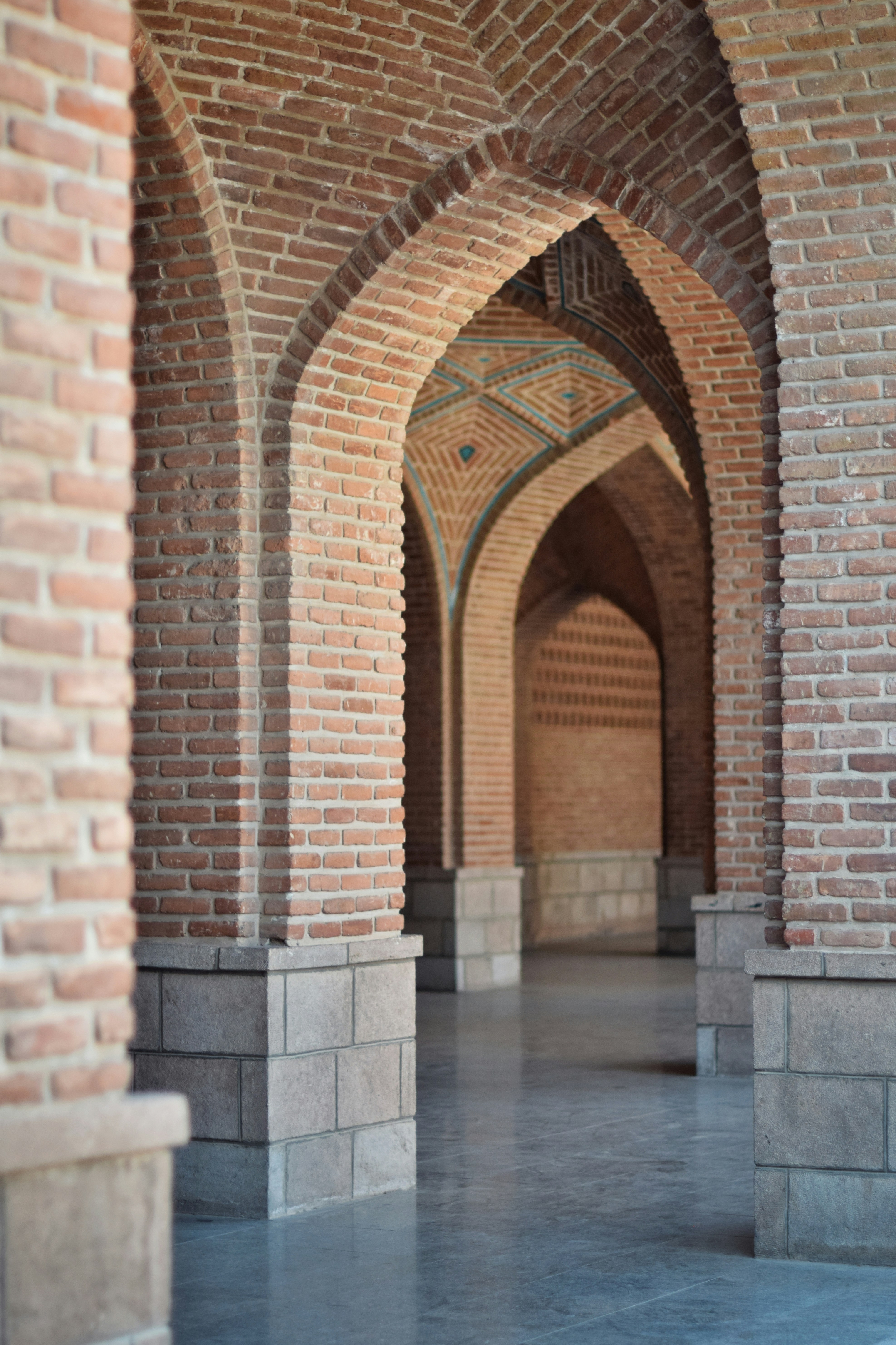 Archway Echoes: Red Brick Vaults Framing Light