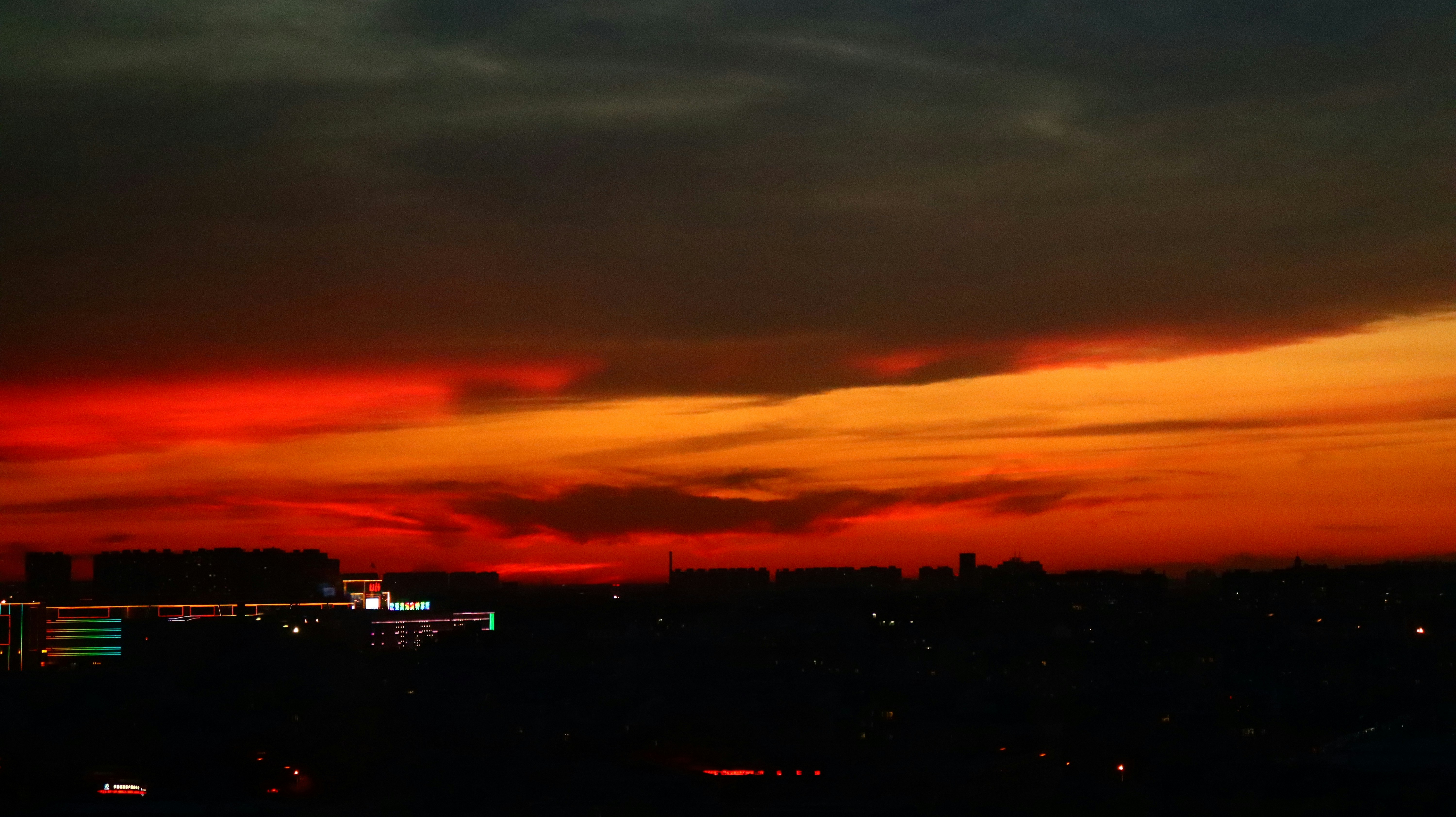 Crimson Horizon Over a Quiet City at Dusk
