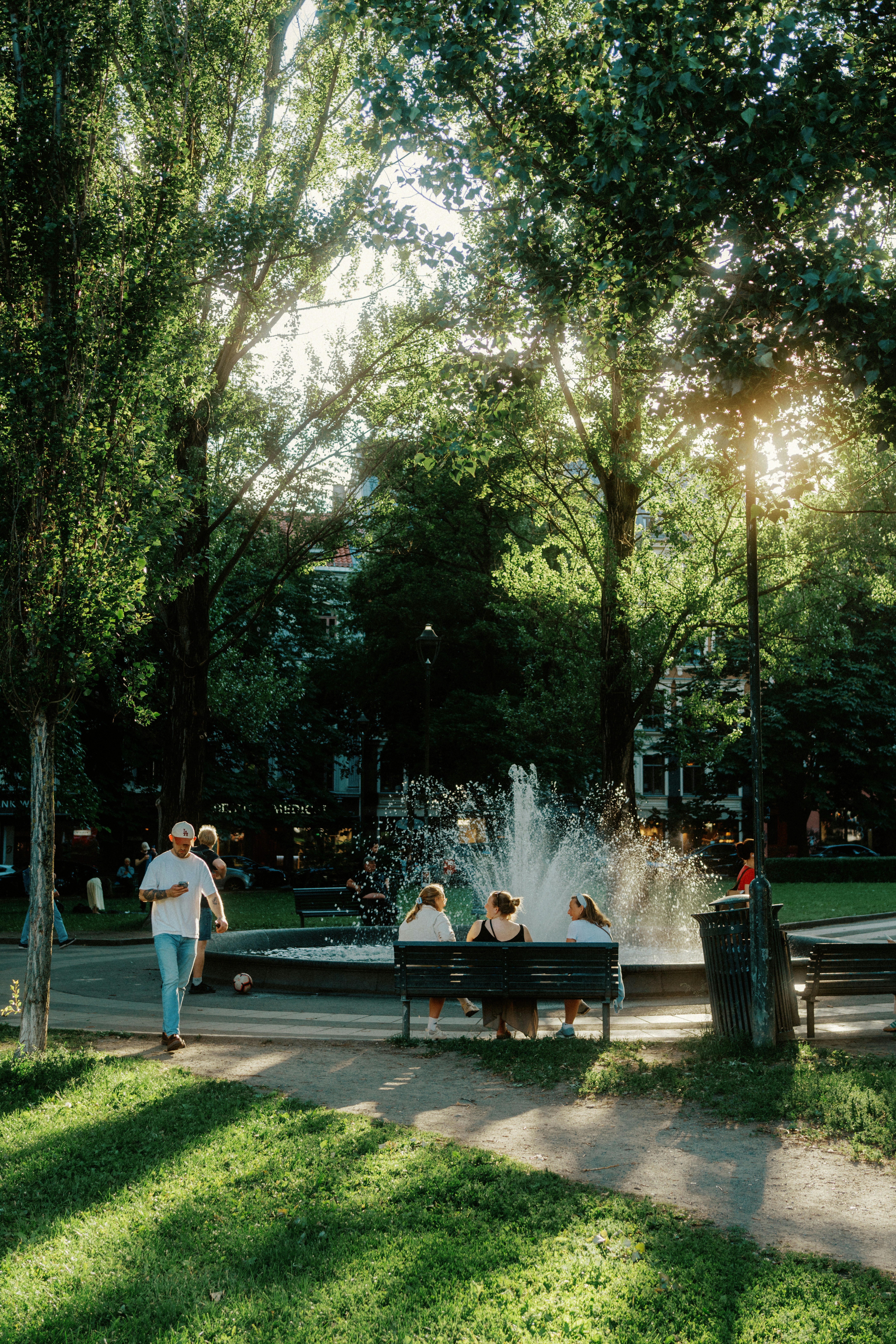 Sunlit Fountain Social: Evening Moments in the Park