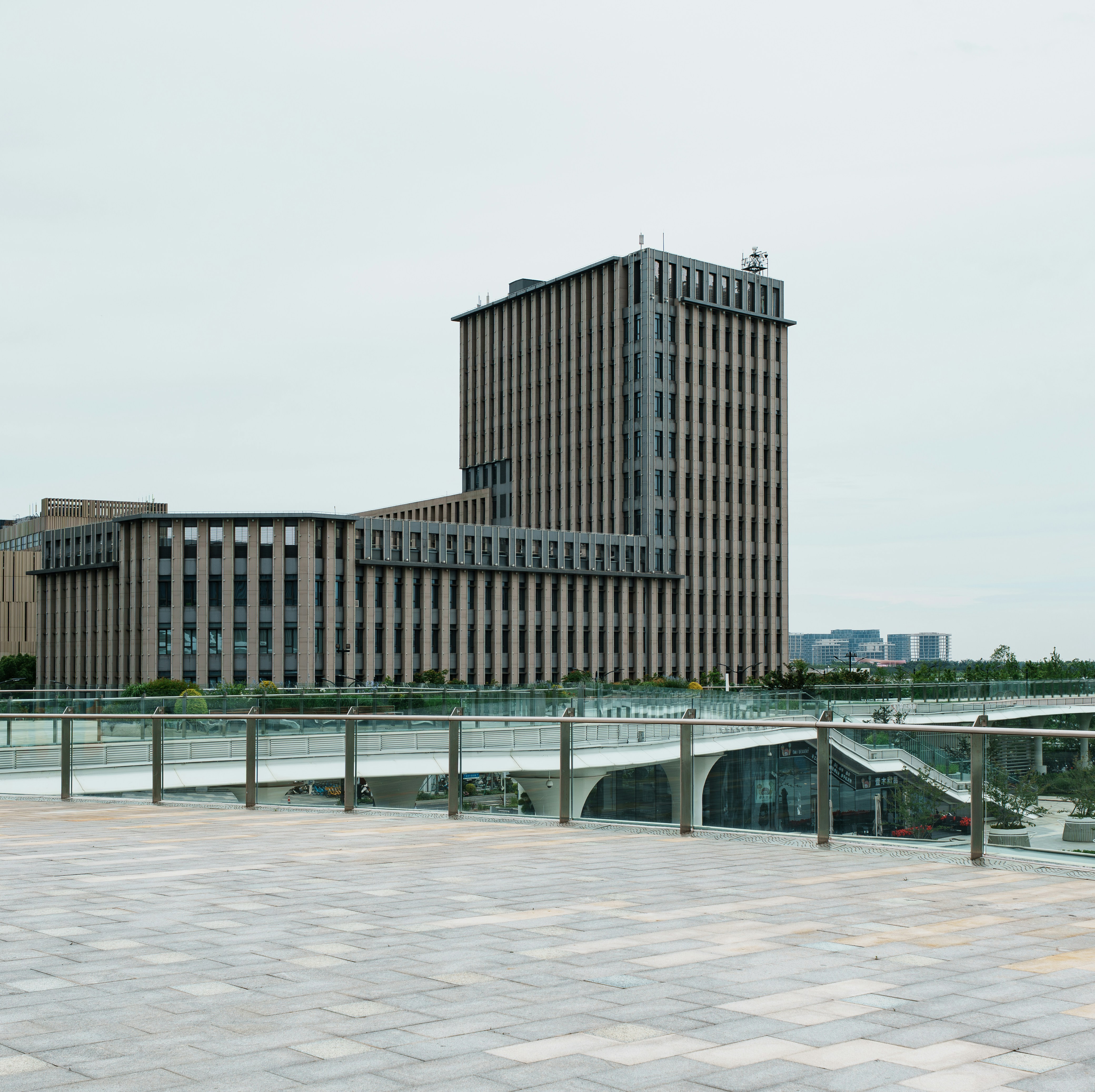 Urban Geometry: The Towering Block Amid a Quiet Plaza