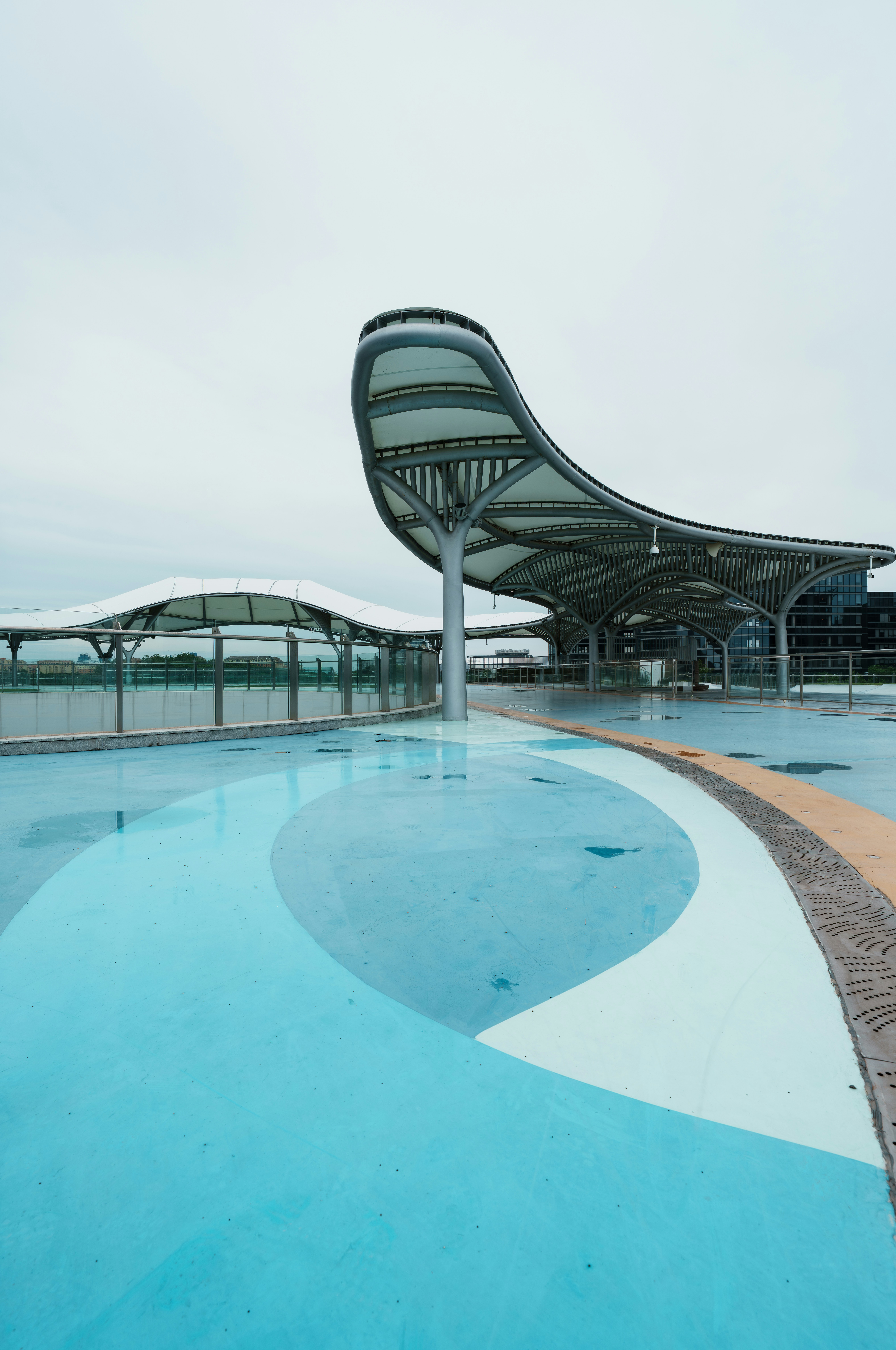 Architectural Canopy Over a Polymer Splash: A Quiet Riverside Walkway