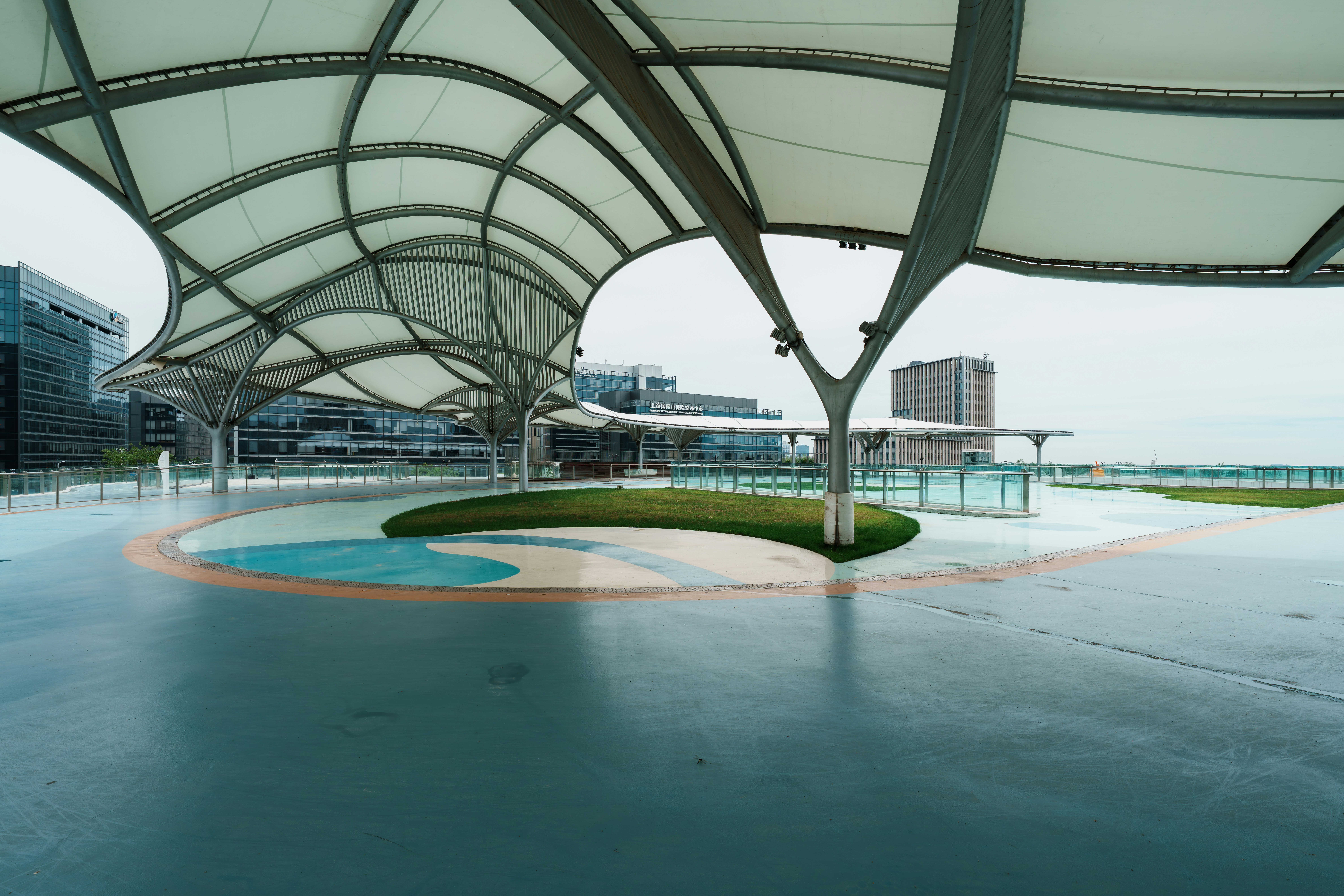 Curved Canopy Over Solar-Patterned Terrace