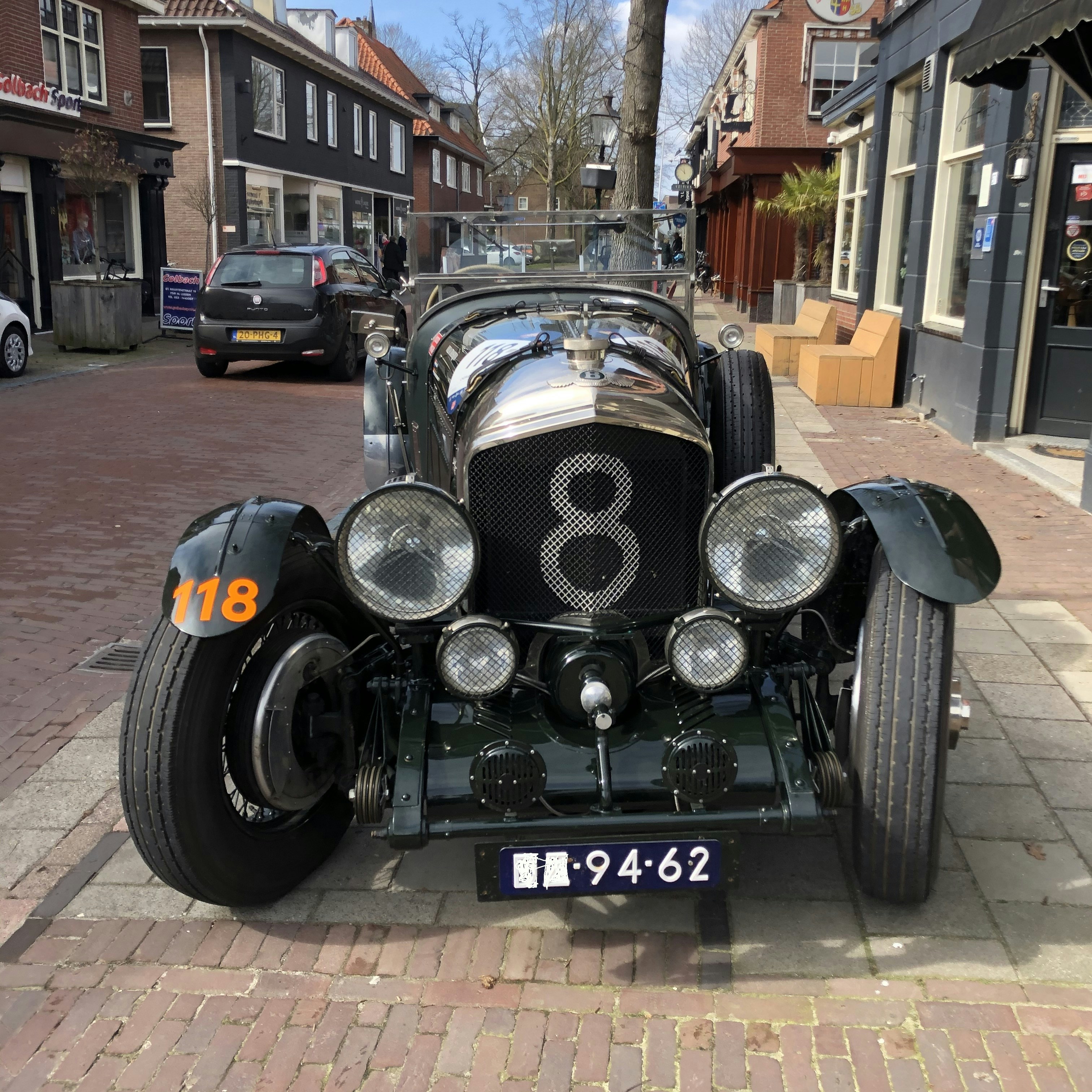 Chrome Conquest: A Classic Automobile Guards the Cobblestones