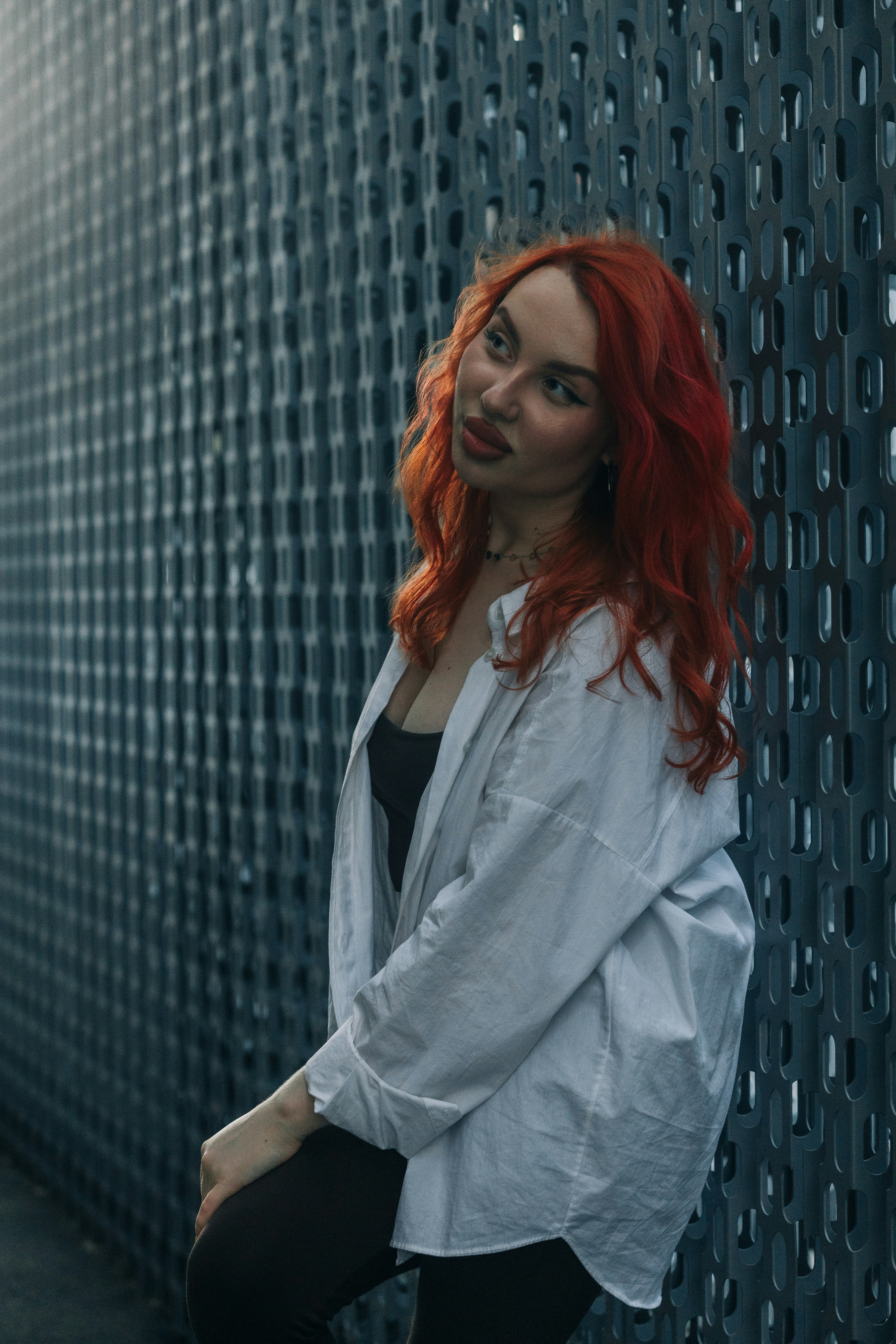 Red-Haired Portrait Against Industrial Grid