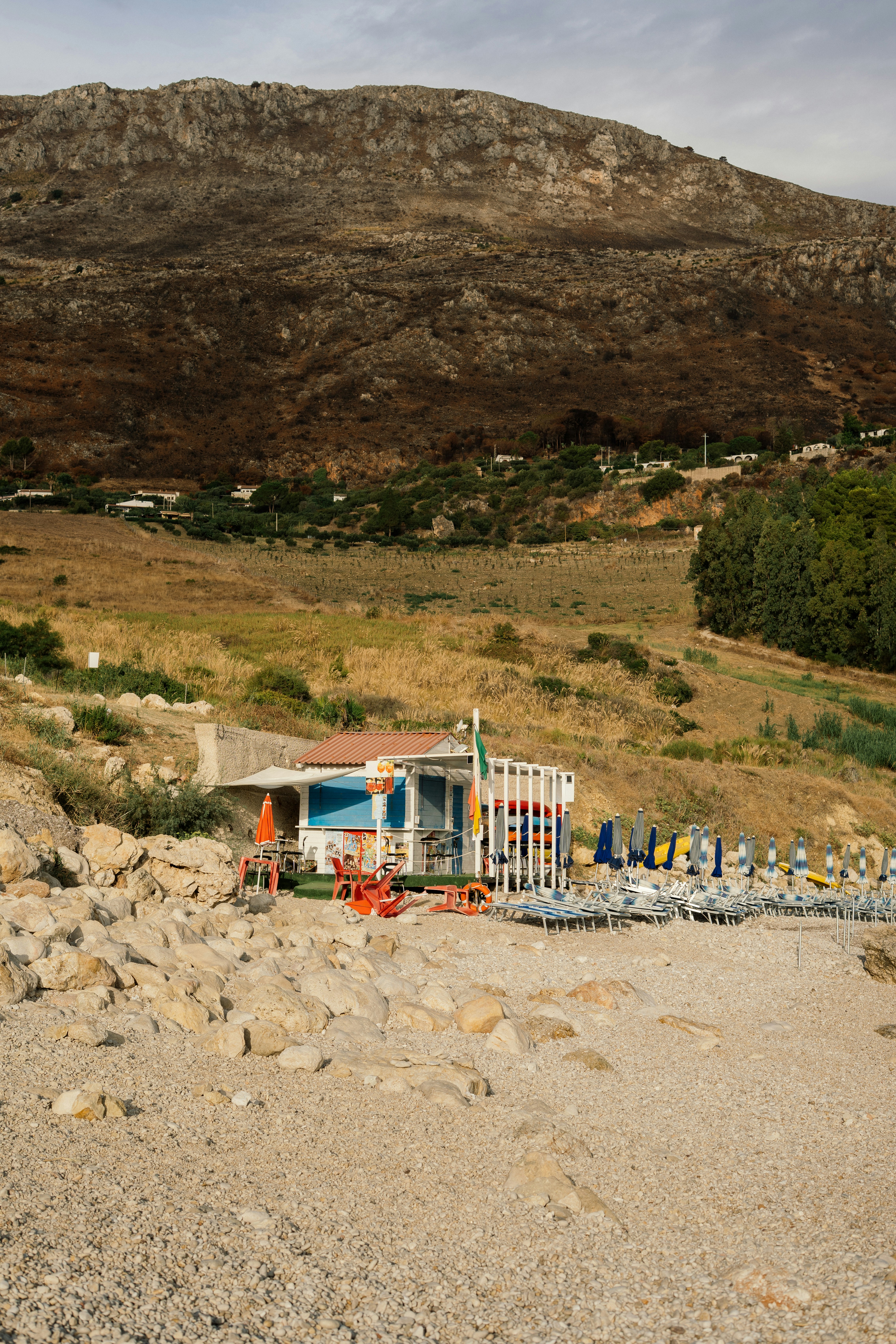 Seaside Clubhouse at the Foot of a Rugged Hill