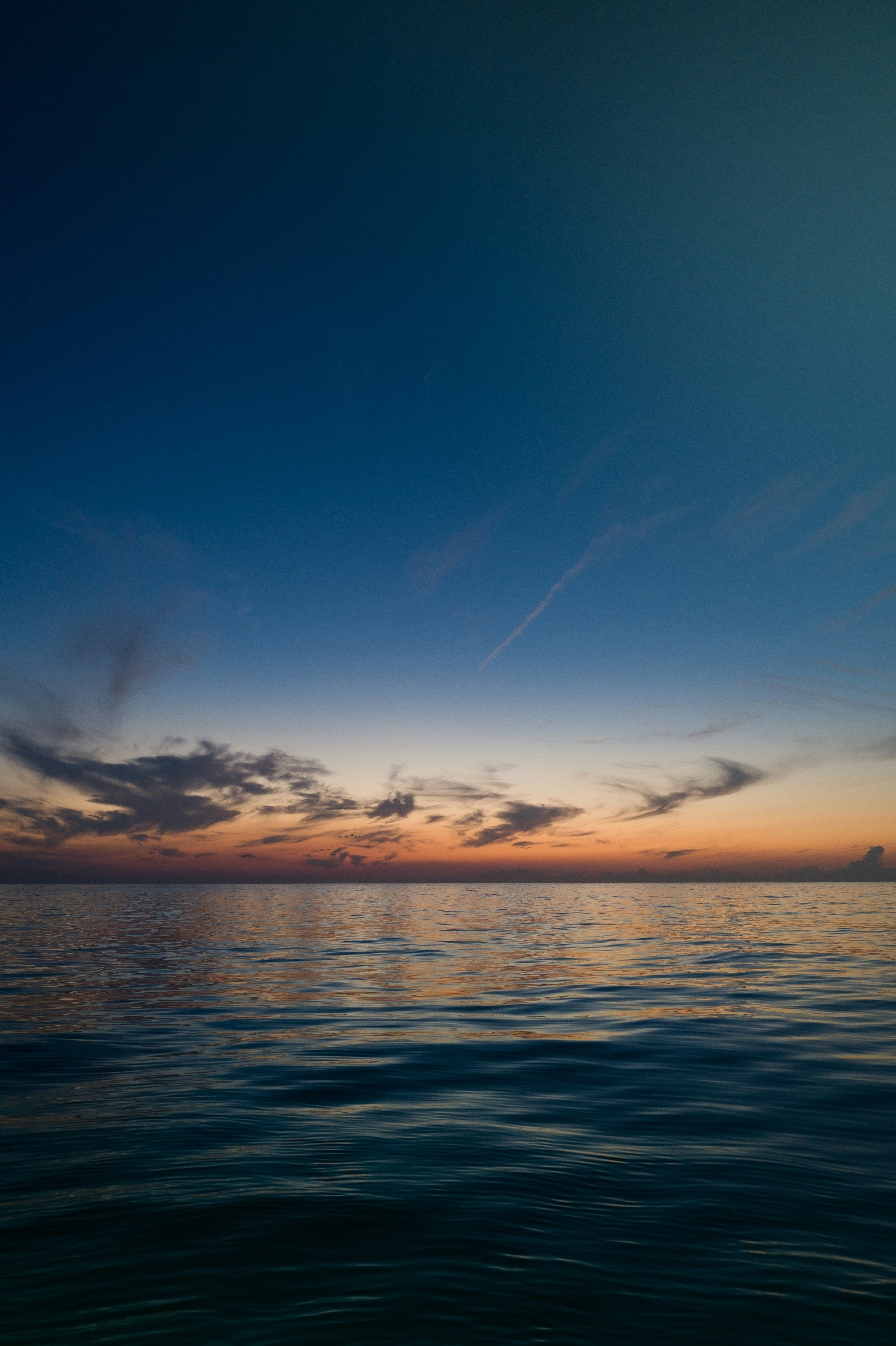 Horizon Kiss at Dusk Over Quiet Seas